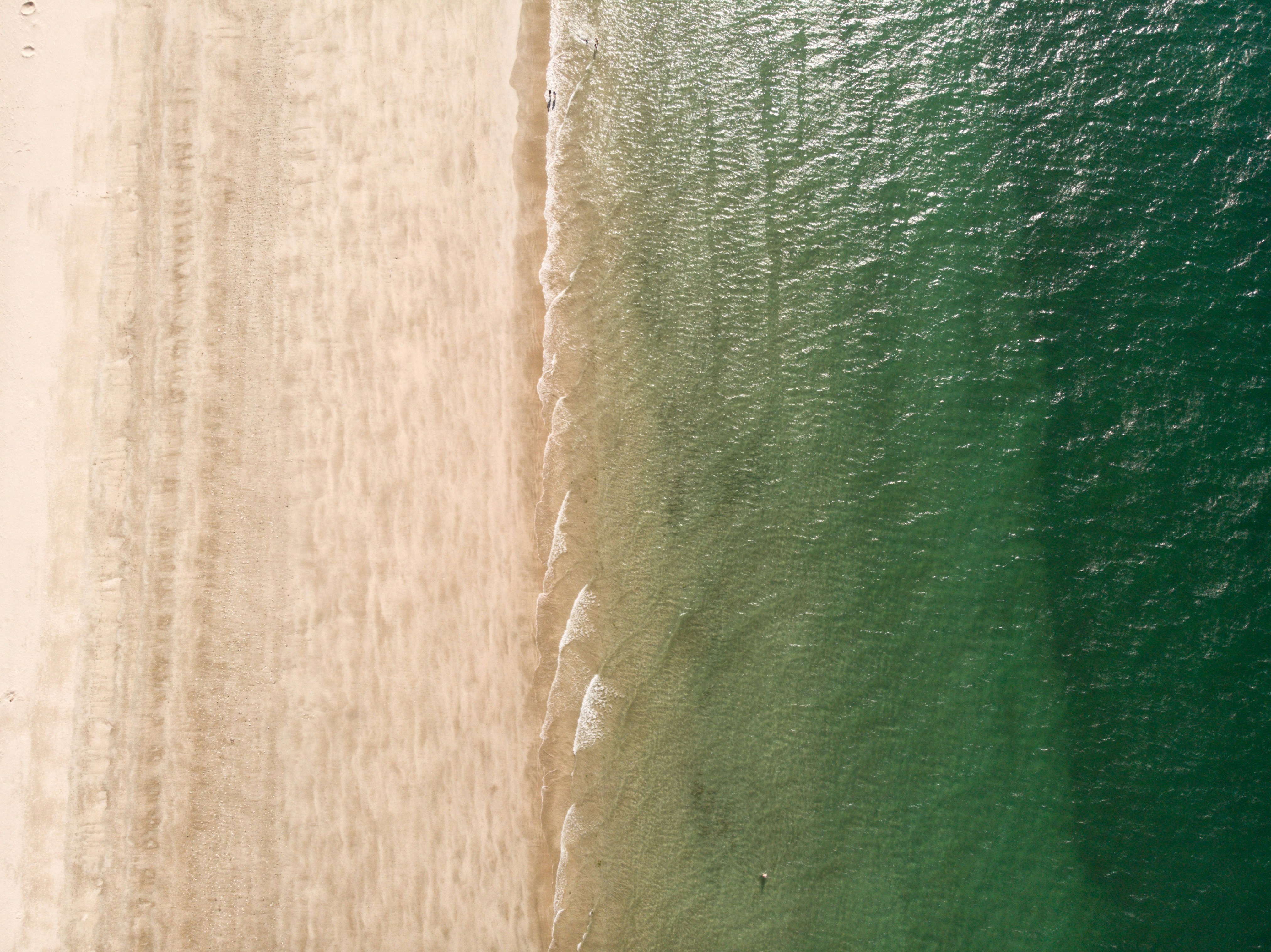 Tideline Divide: Aerial Cross-section of Sand and Sea