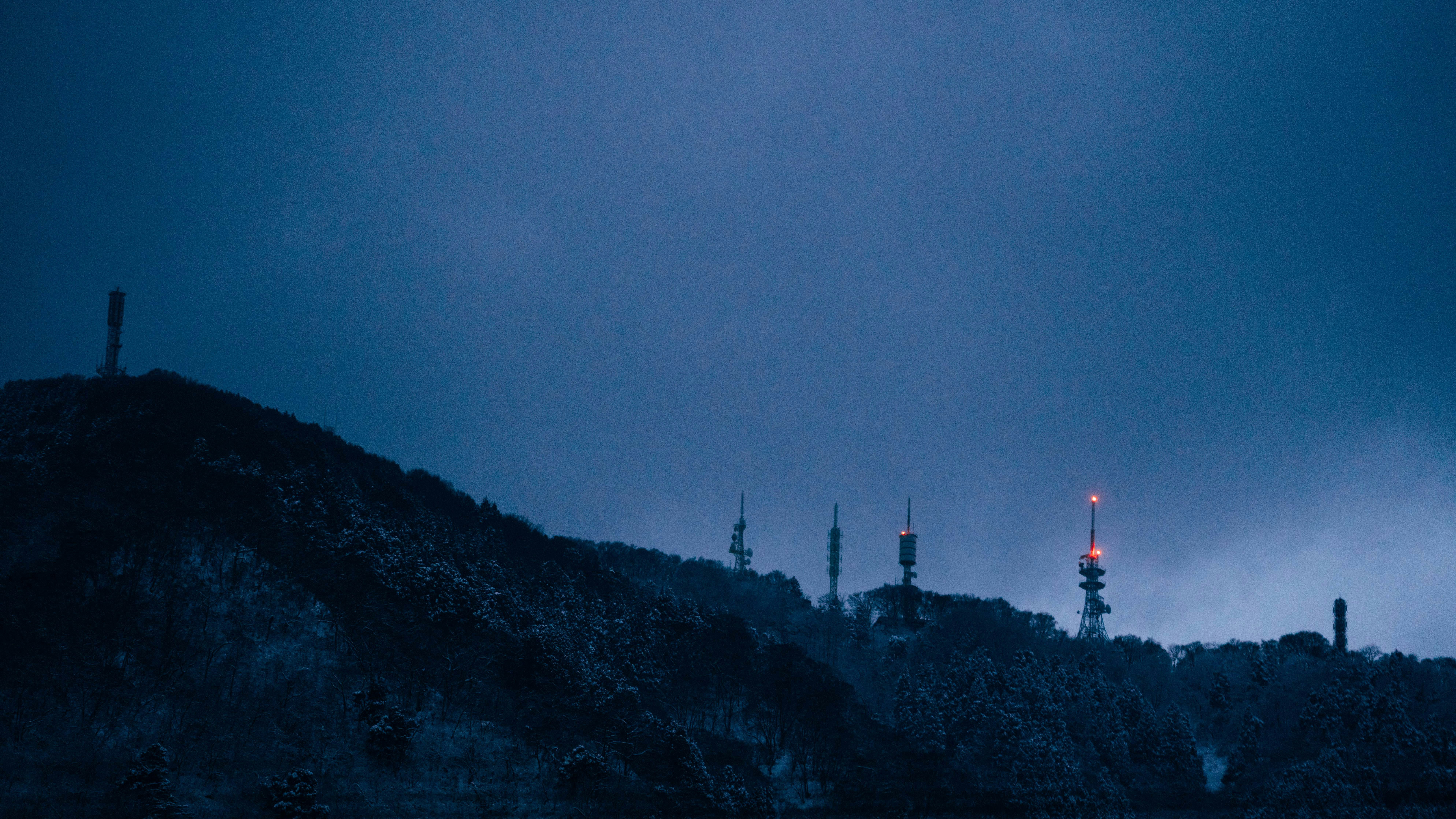 A dark blue sky with some very tall towers photo – Free Blue Image on ...