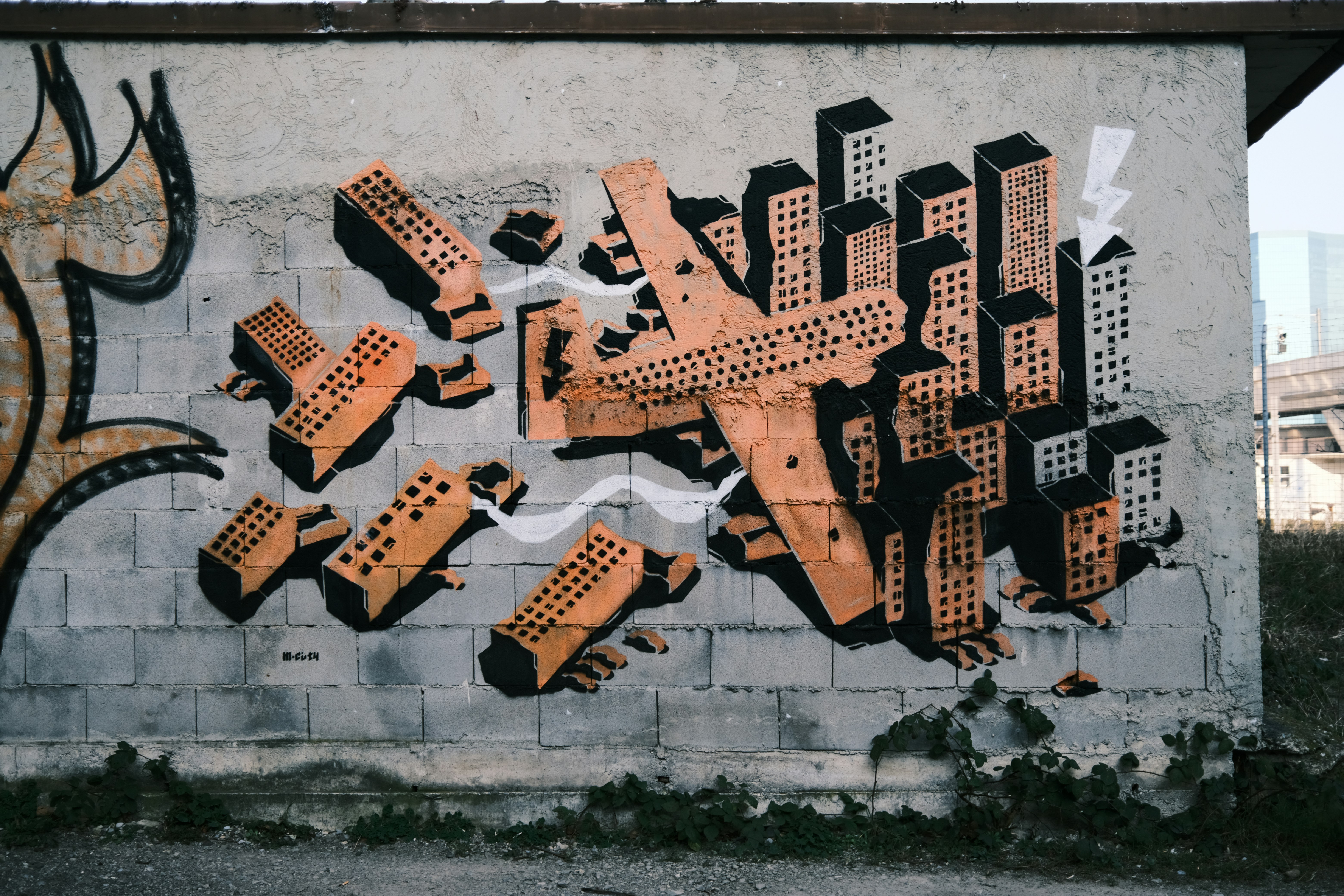 Brick-Block Graffiti: Orange 3D Letters Rise on a Weathered Wall