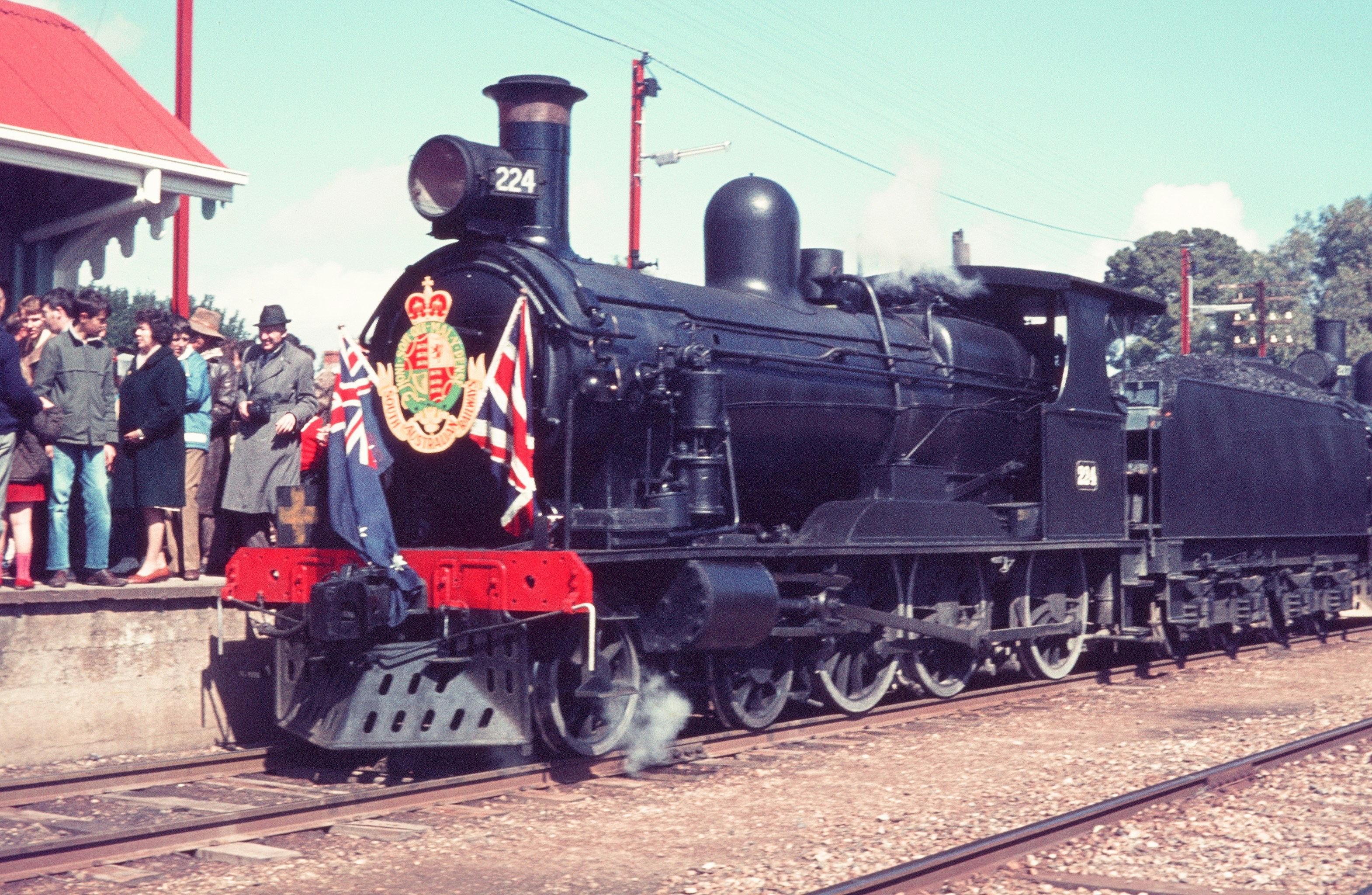 A black train with people standing on the side of it photo – Free ...