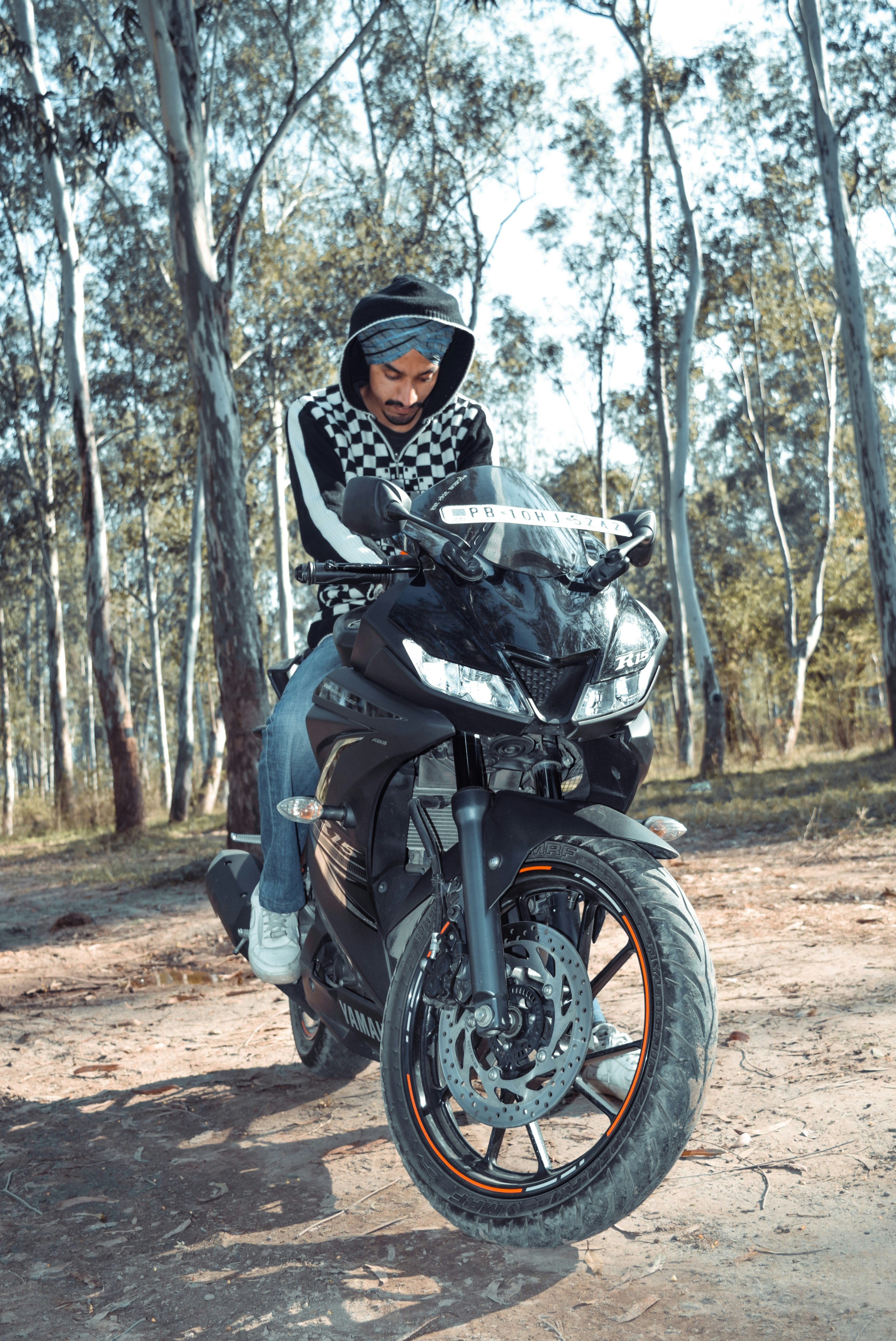 A man riding on the back of a motorcycle photo – Free Grey Image on ...