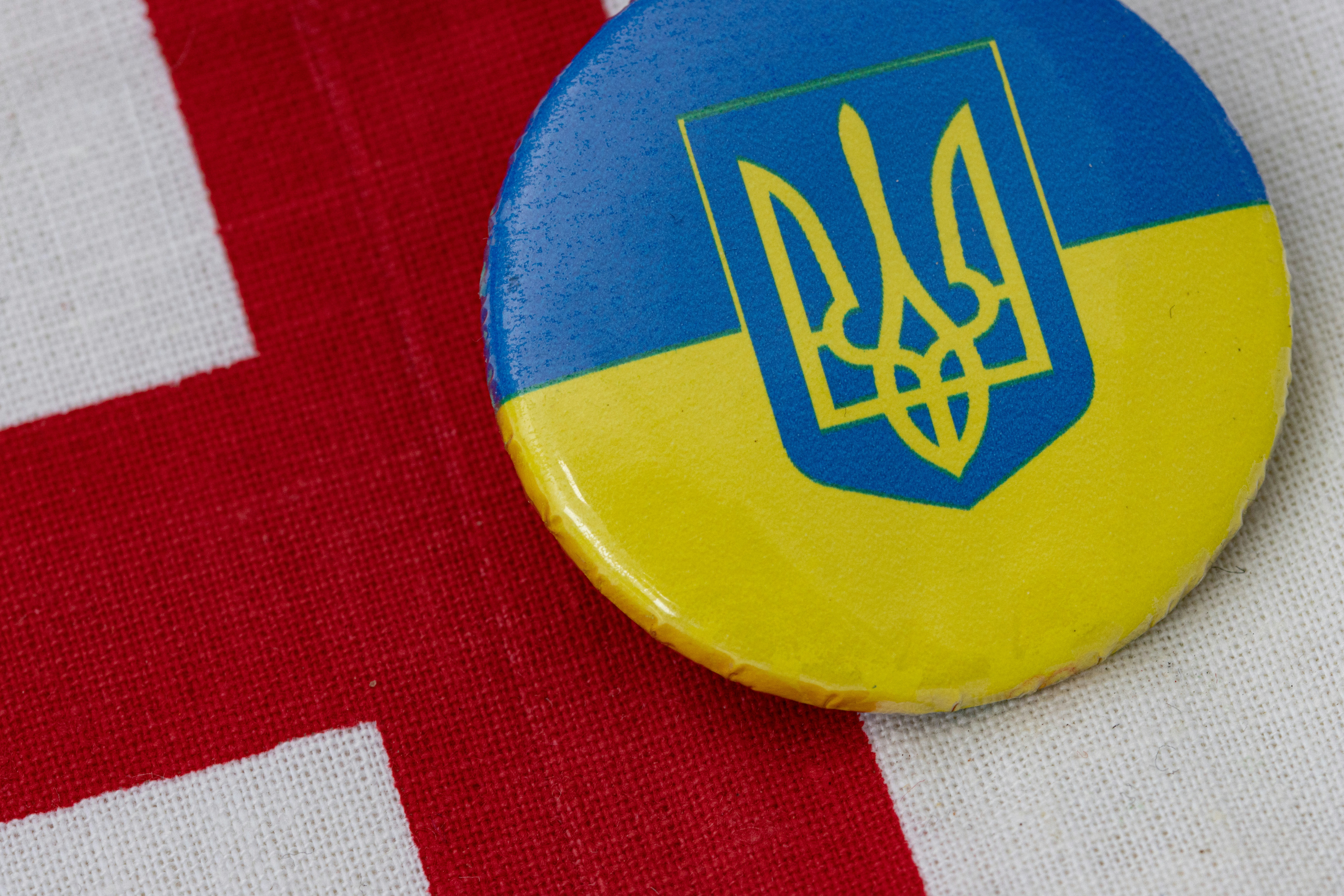 Close-Up Trident Pin on Blue-and-Yellow Fabric