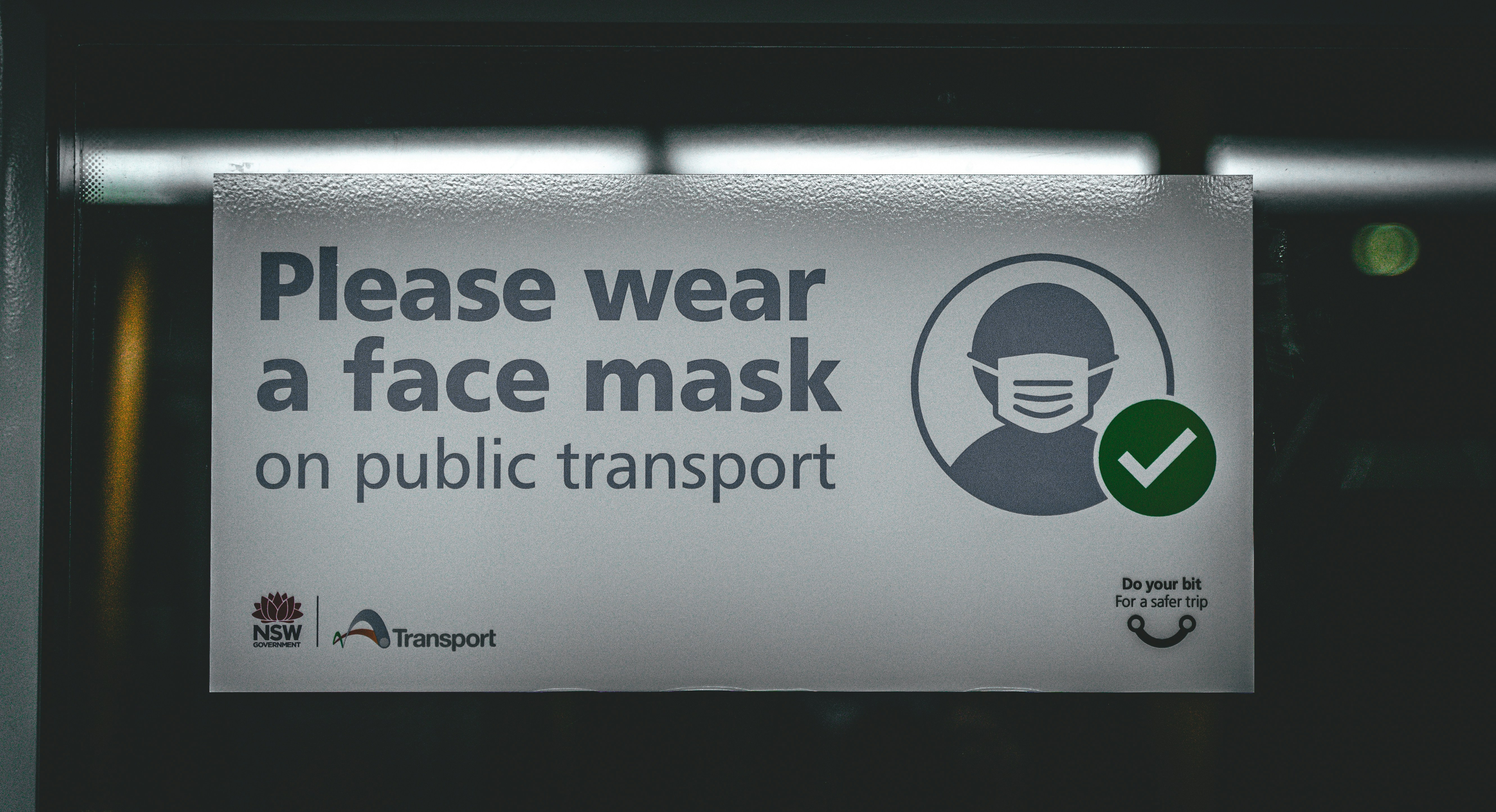 A sign on a public transportation bus warning people to wear a face ...