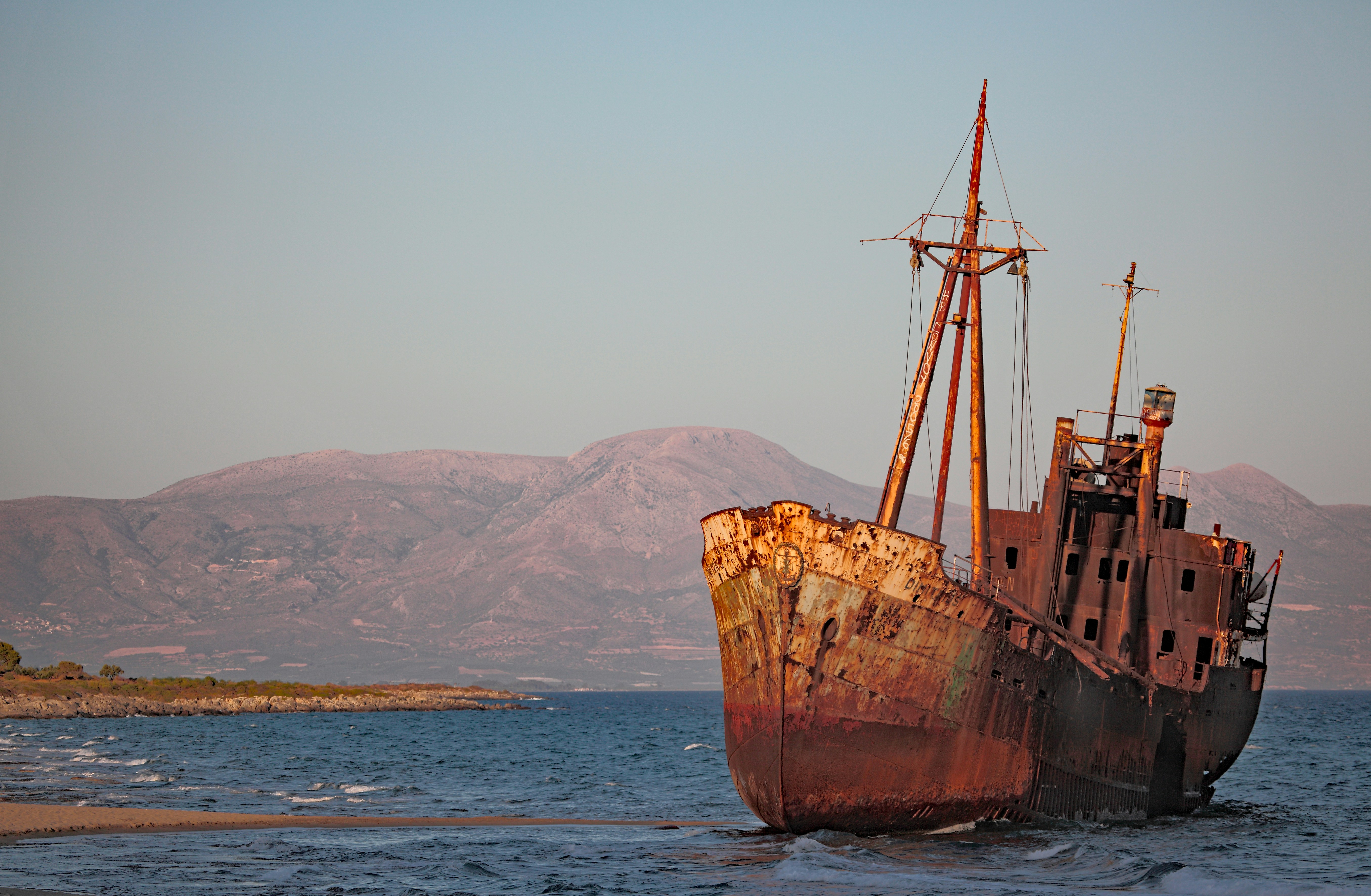 An old rusted ship in the middle of the ocean photo – Free Rusted ship ...
