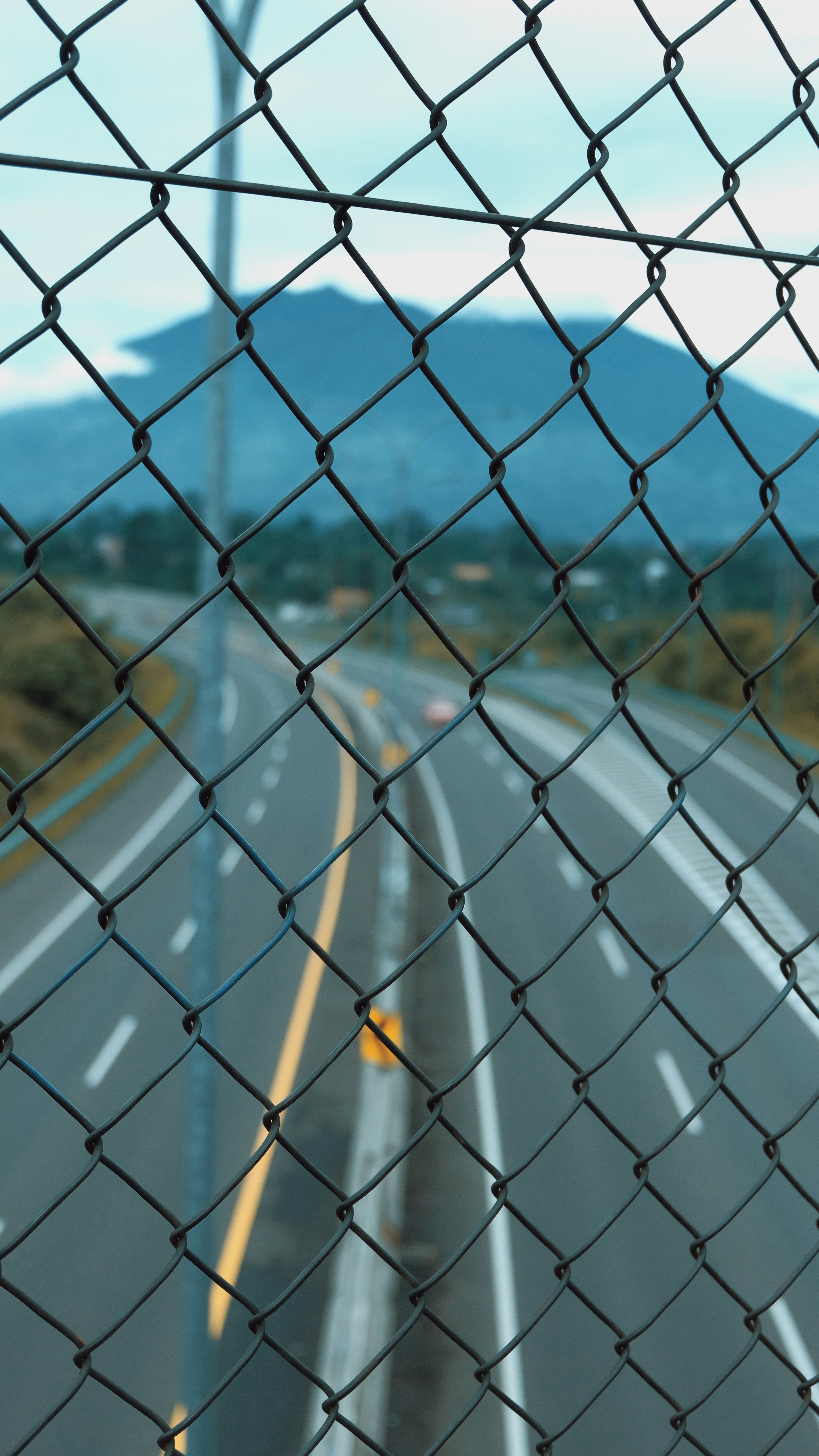 A view of a highway through a chain link fence photo – Free Ciawi Image ...