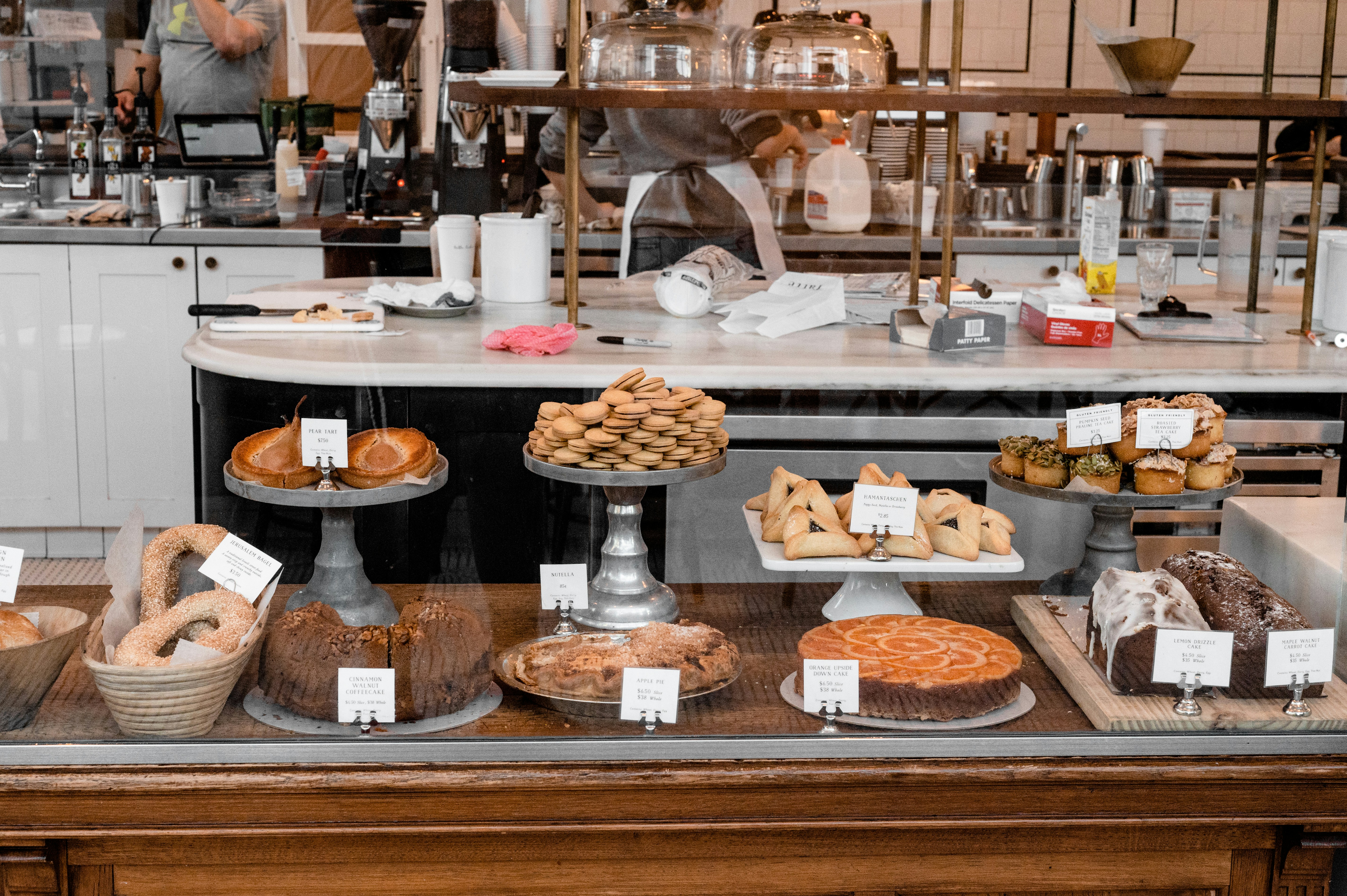 A bakery counter filled with lots of pastries photo – Free Food Image ...