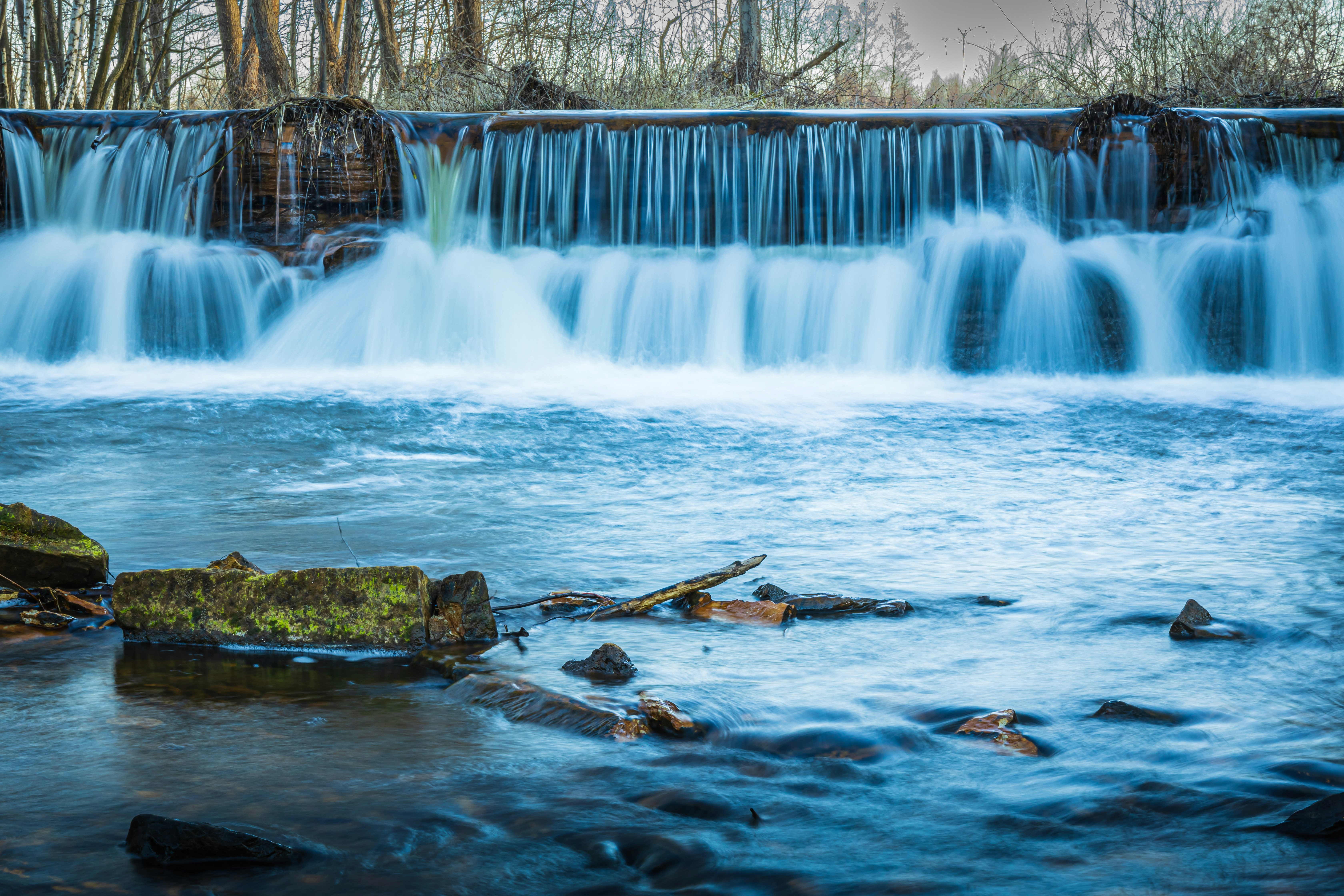 A large waterfall with water running over rocks photo – Free River ...