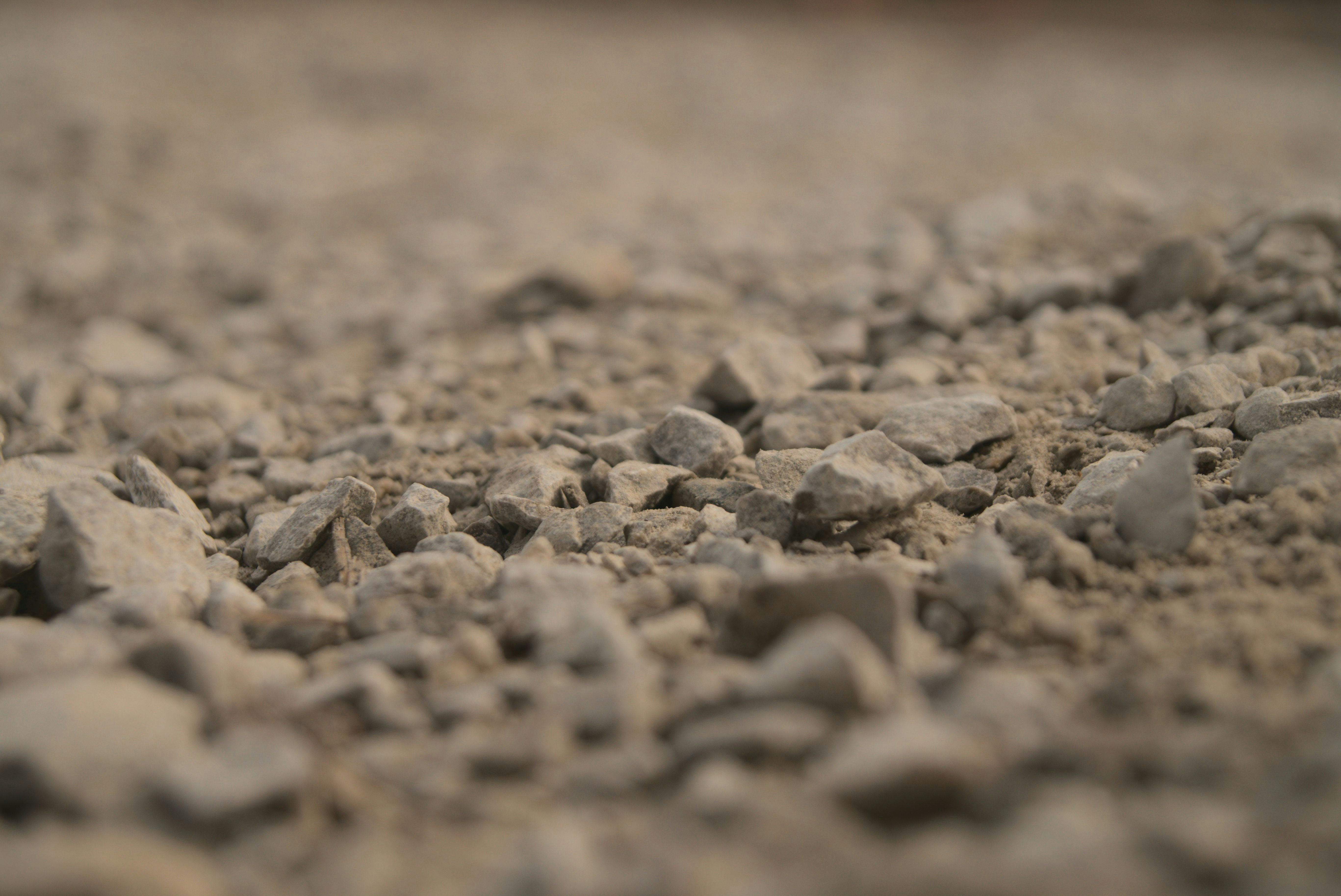 A close up of rocks and gravel with a blurry background photo – Free ...