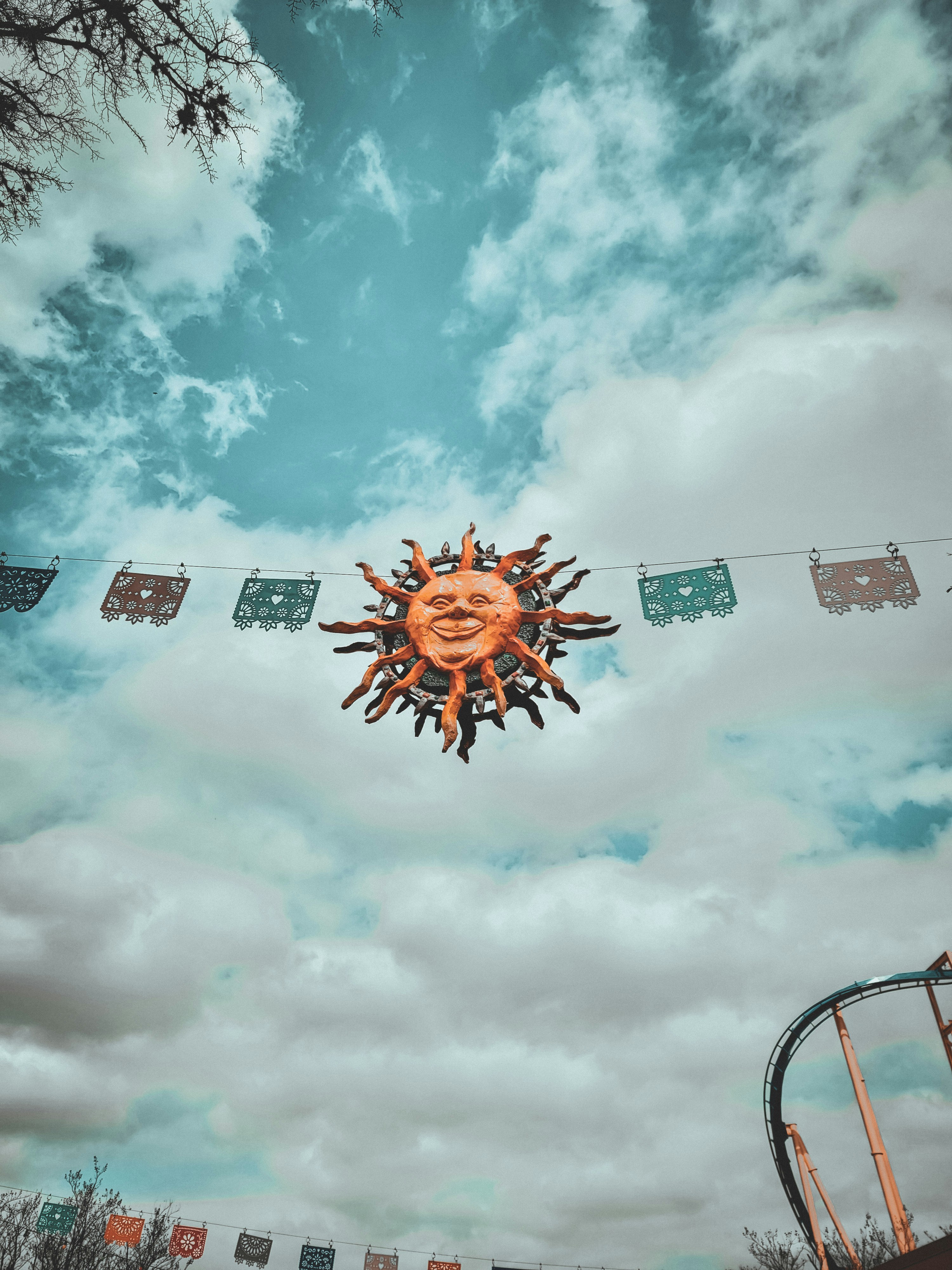 A large orange sun sitting on top of a metal pole photo – Free Black ...