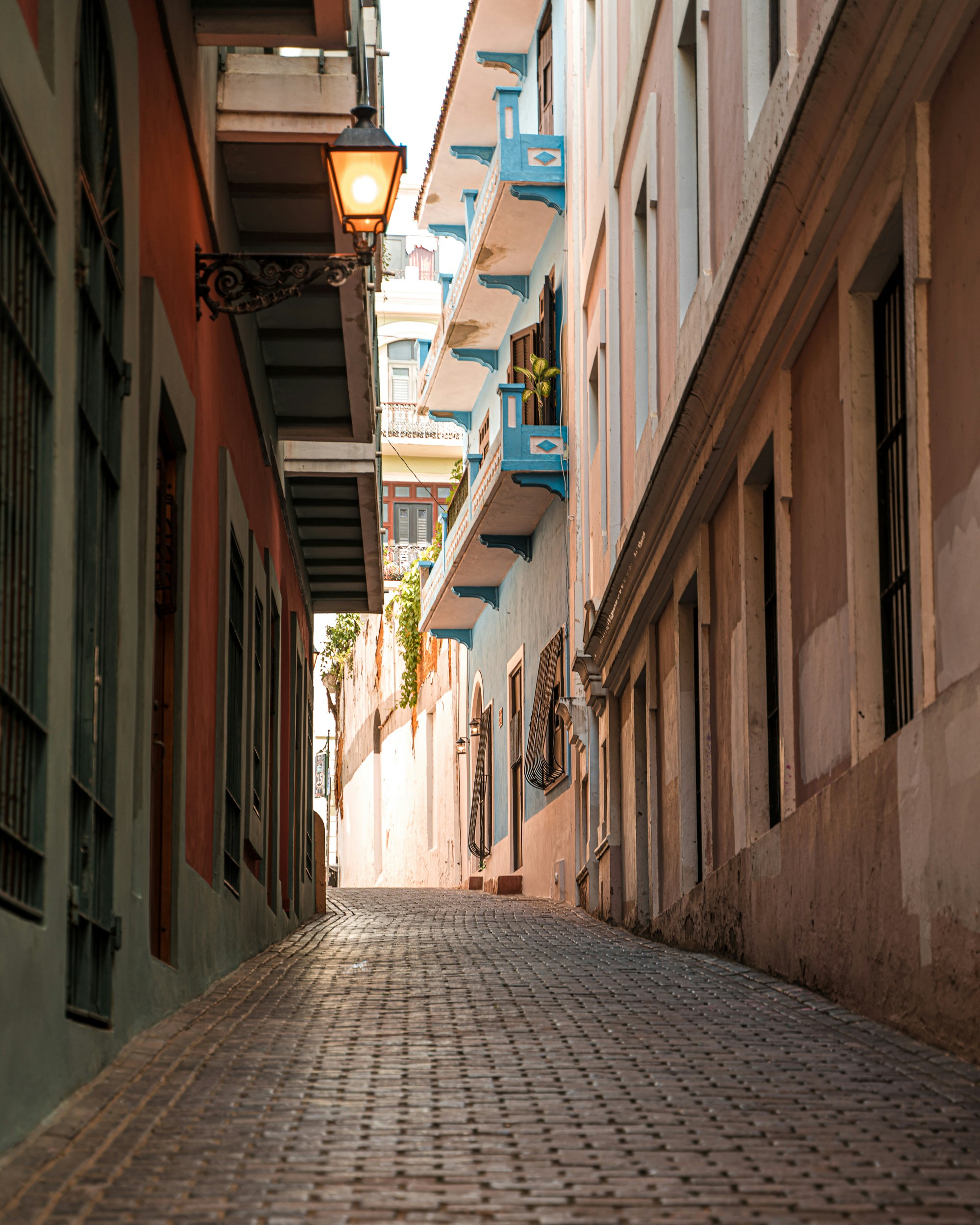 A cobblestone street lined with tall buildings photo – Free Puerto rico ...