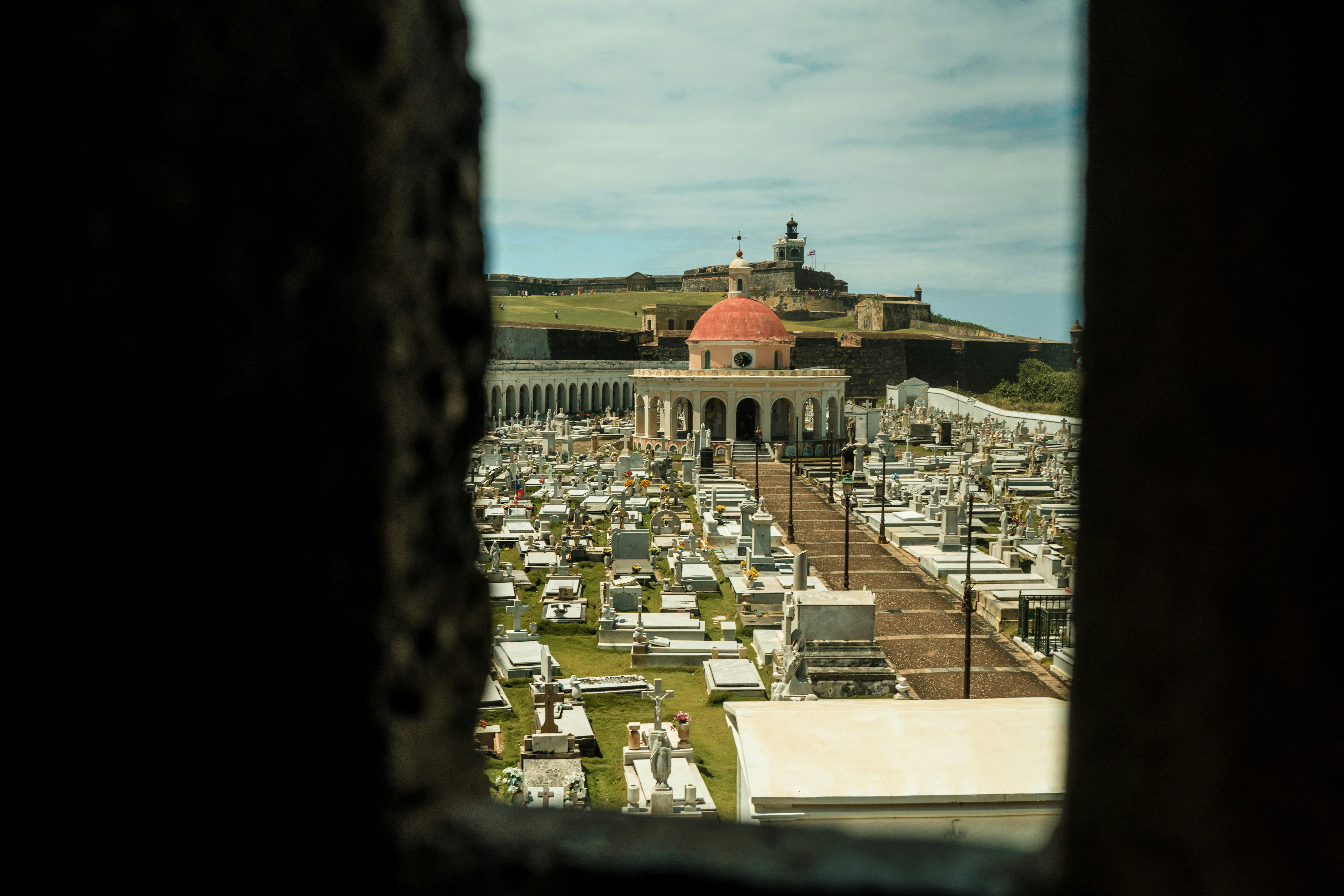 Pink-Domed Chapel Above a Sea of Monuments, Seen Through a Window