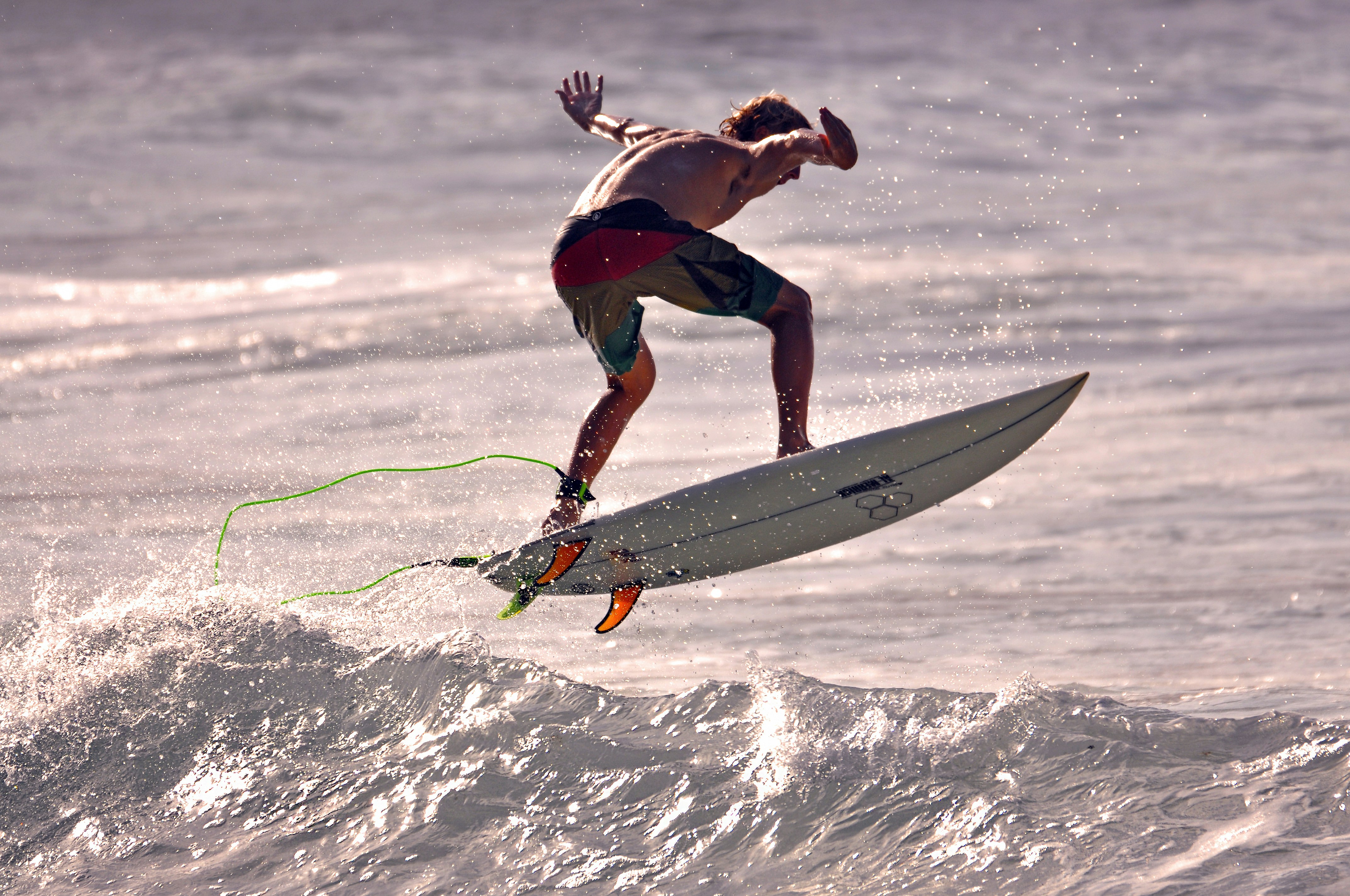 A man riding a surfboard on top of a wave photo – Free Usa Image on ...