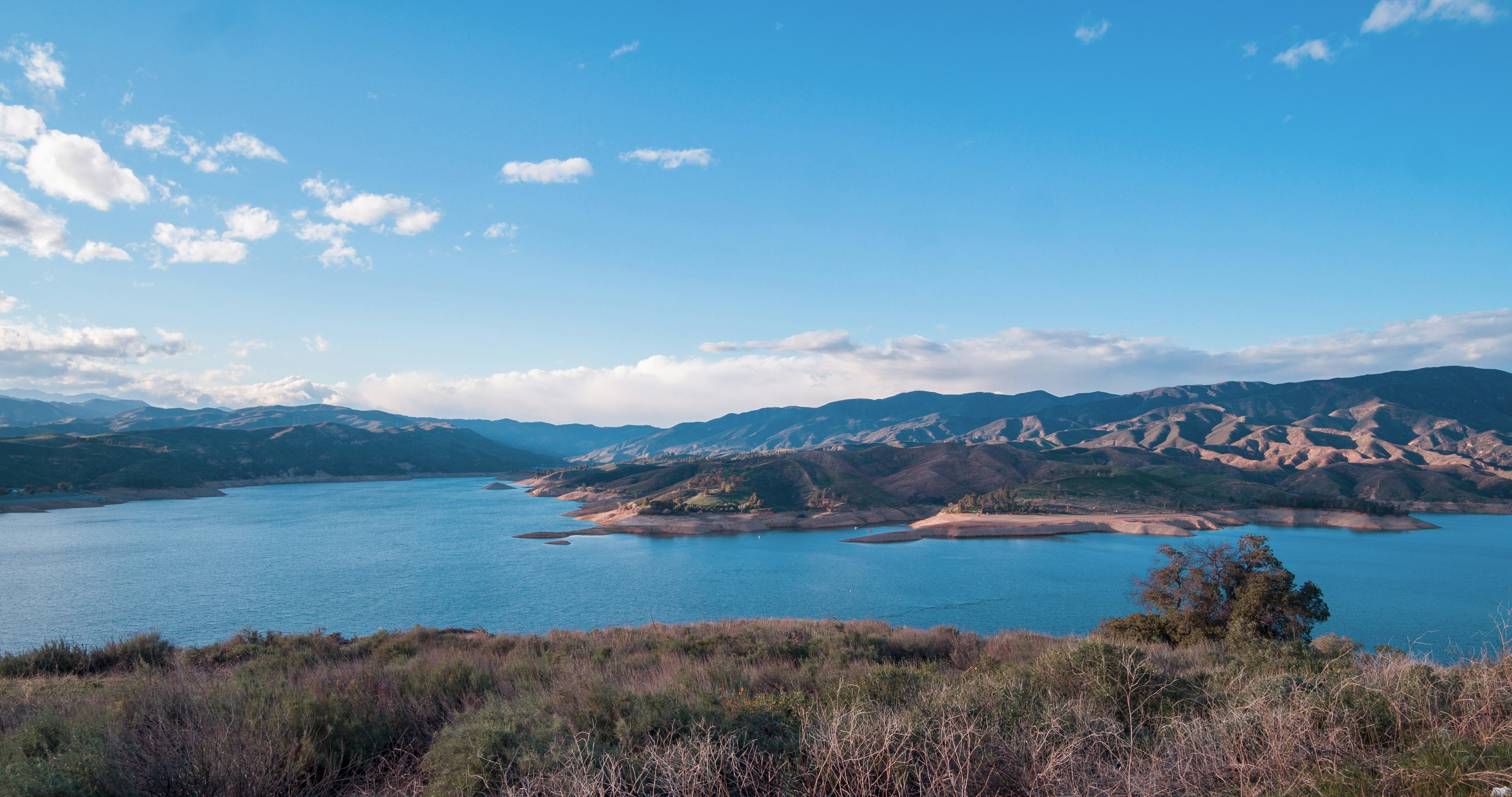A large body of water surrounded by mountains photo – Free Castaic lake ...
