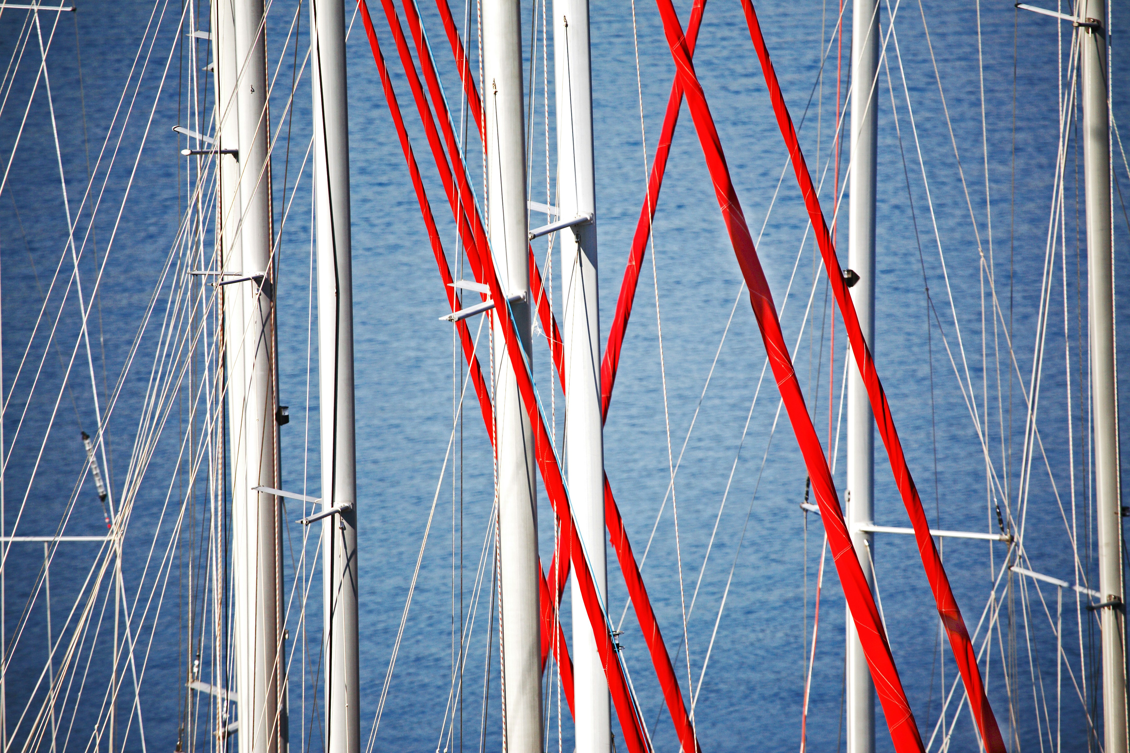 The masts of a sailboat are red and white photo – Free Masts Image on ...