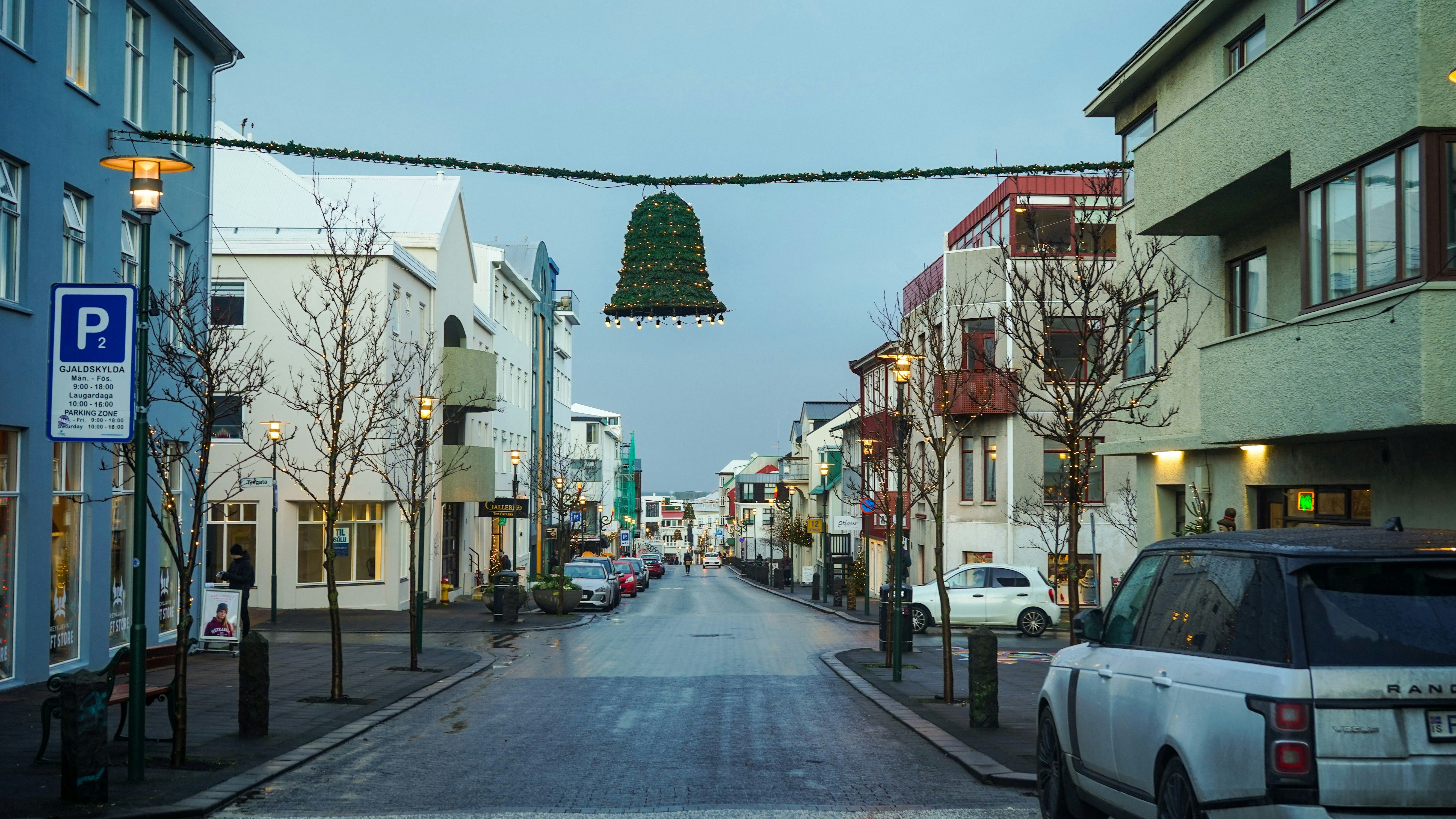 empty street at christmas time in reykjavik, dec 2021 | a street with cars parked on both sides of it