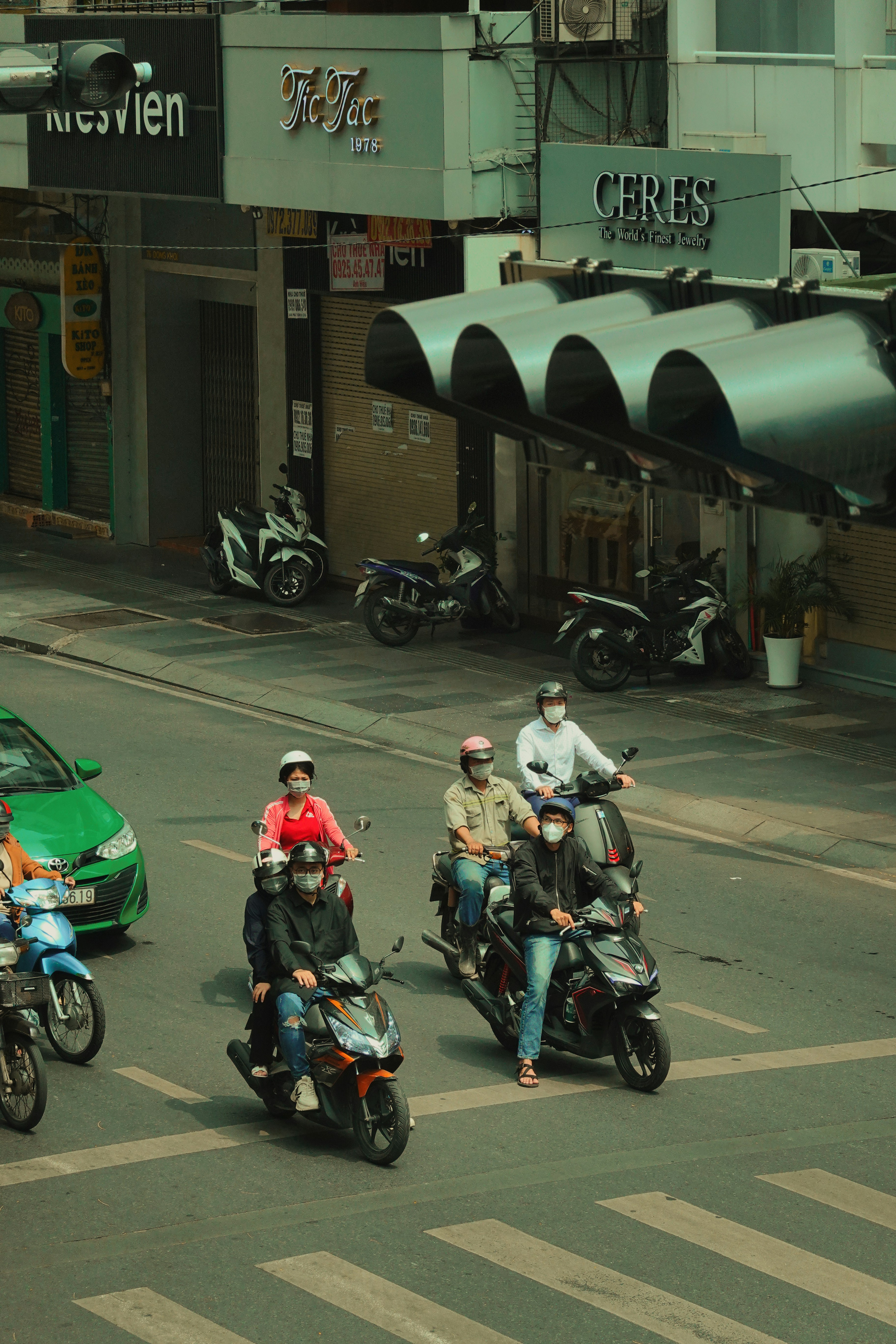 A group of people riding motorcycles down a street photo – Free Ho chi ...