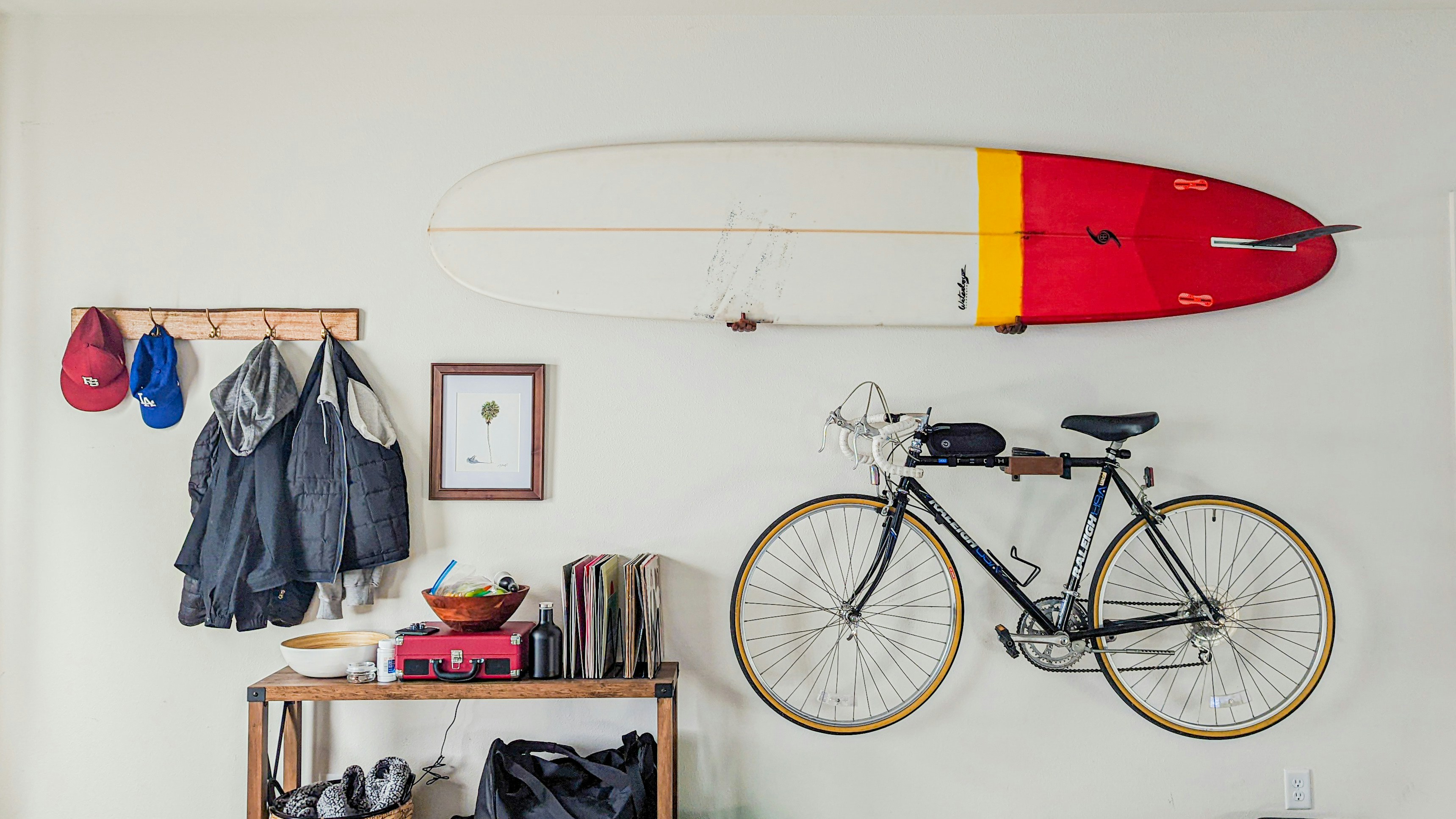 a bike mounted to a wall next to a shelf