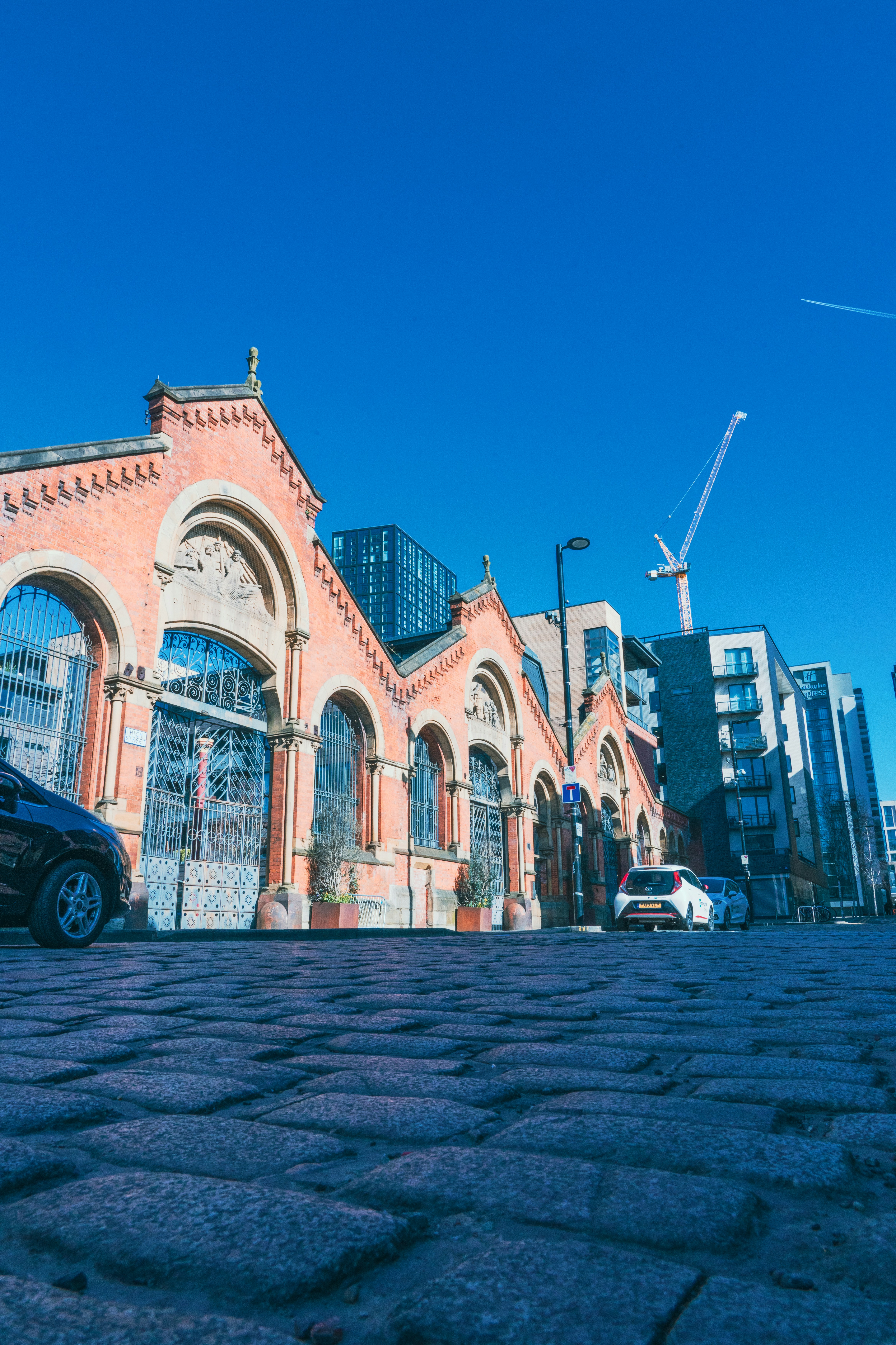 Red-brick Arches Framing a Modern City Under a cobalt Sky