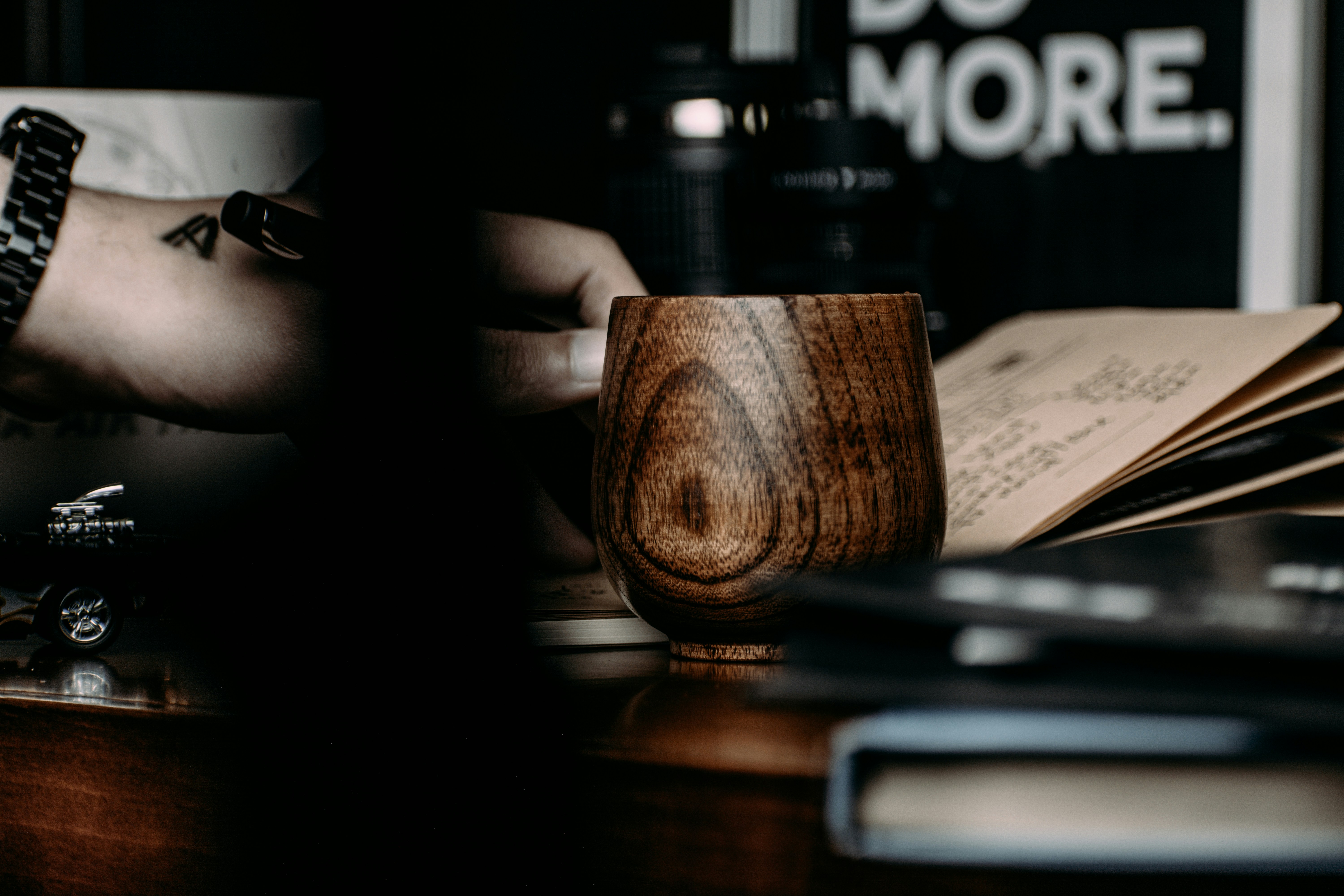 a wooden desk topped with lots of books