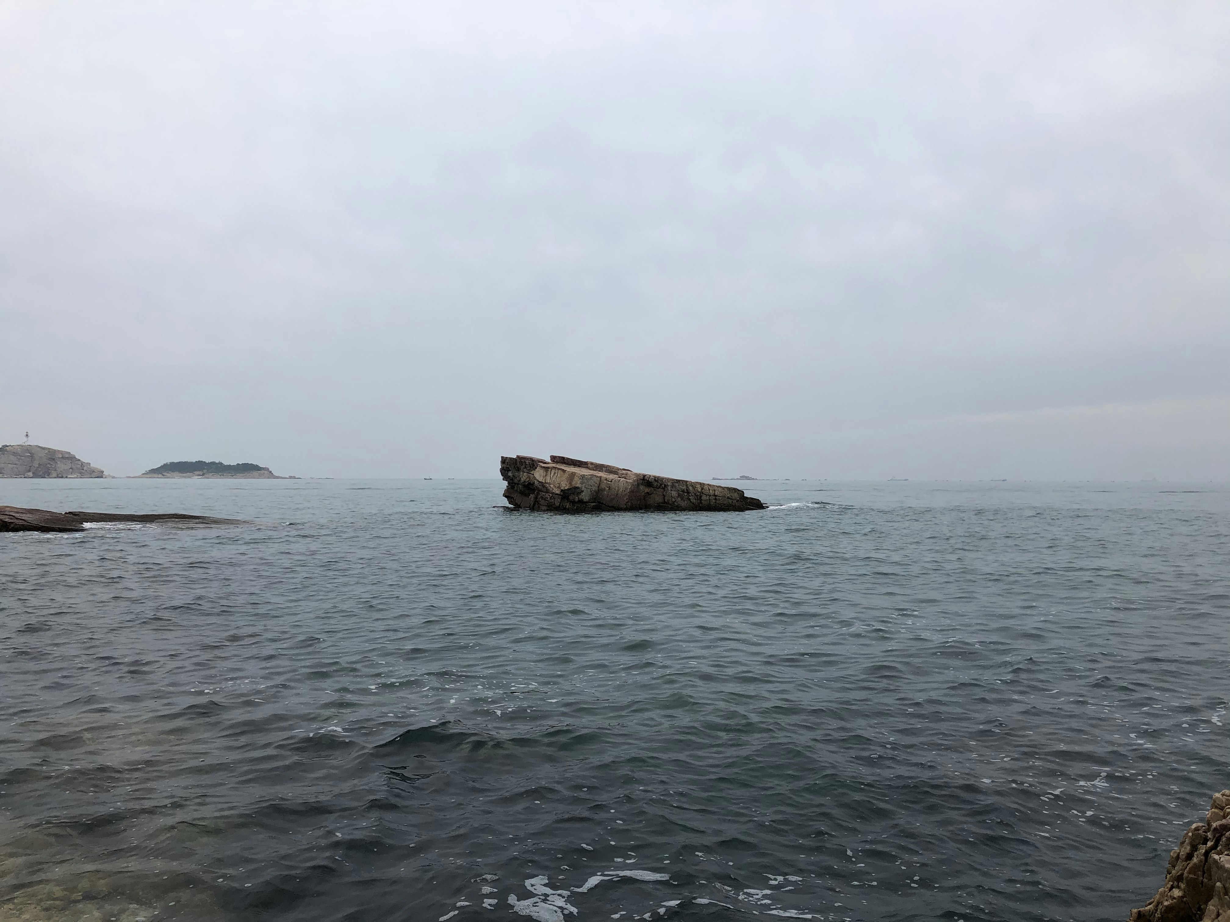The Quiet Rock at the Edge of Gray Waters
