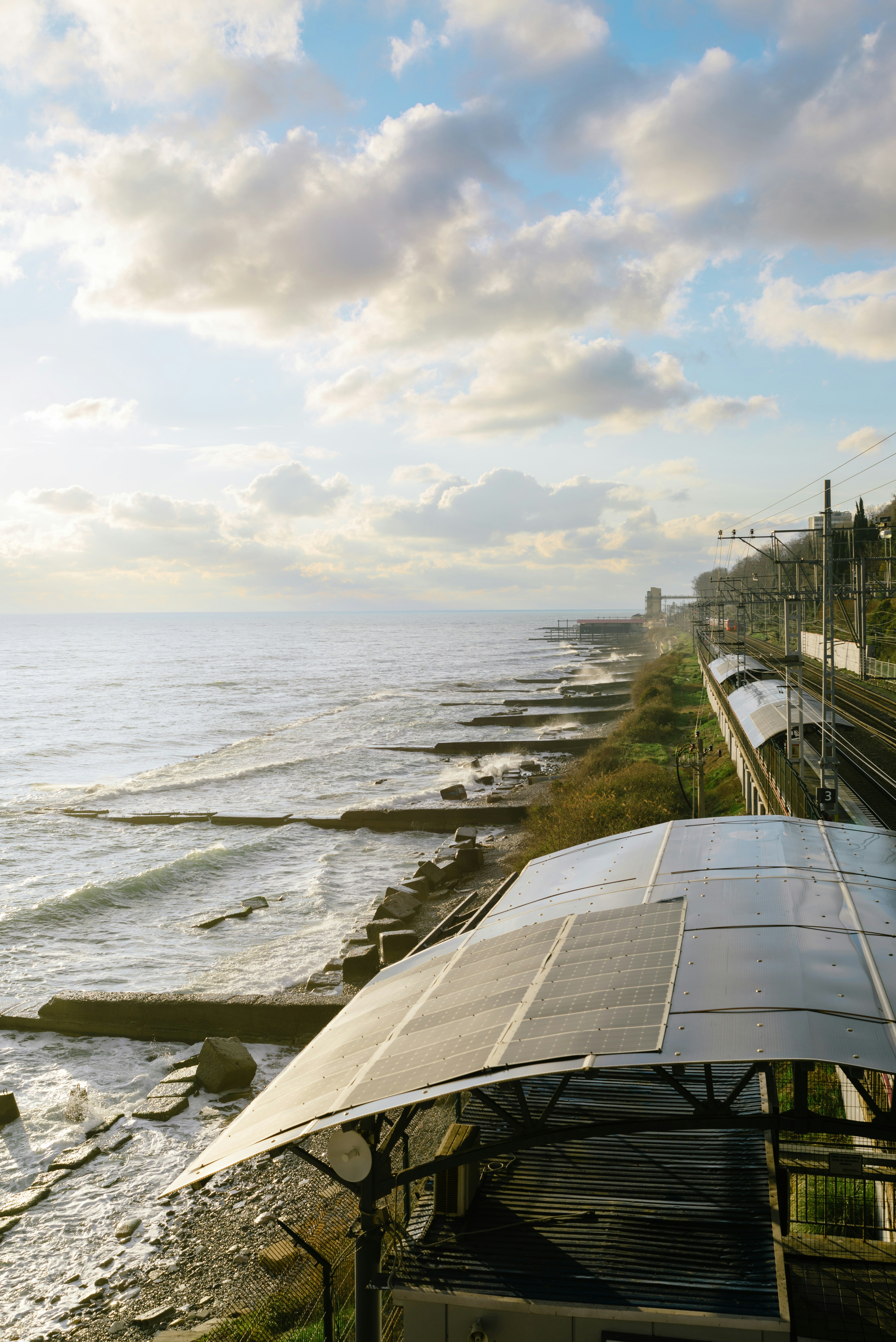 Solar Panels Meet the Sea: A Train Platform at Dusk