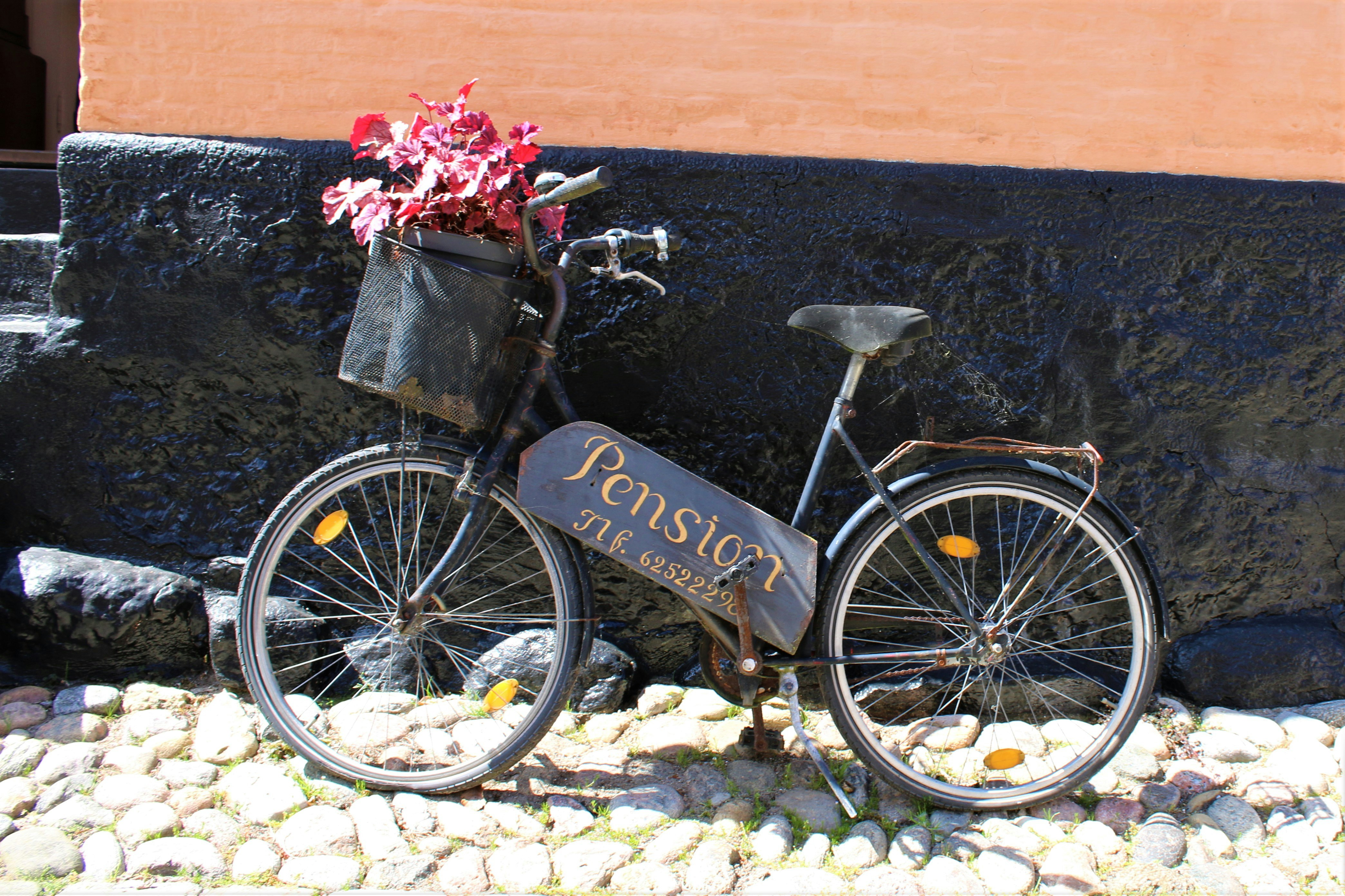 a bicycle parked next to a stone wall