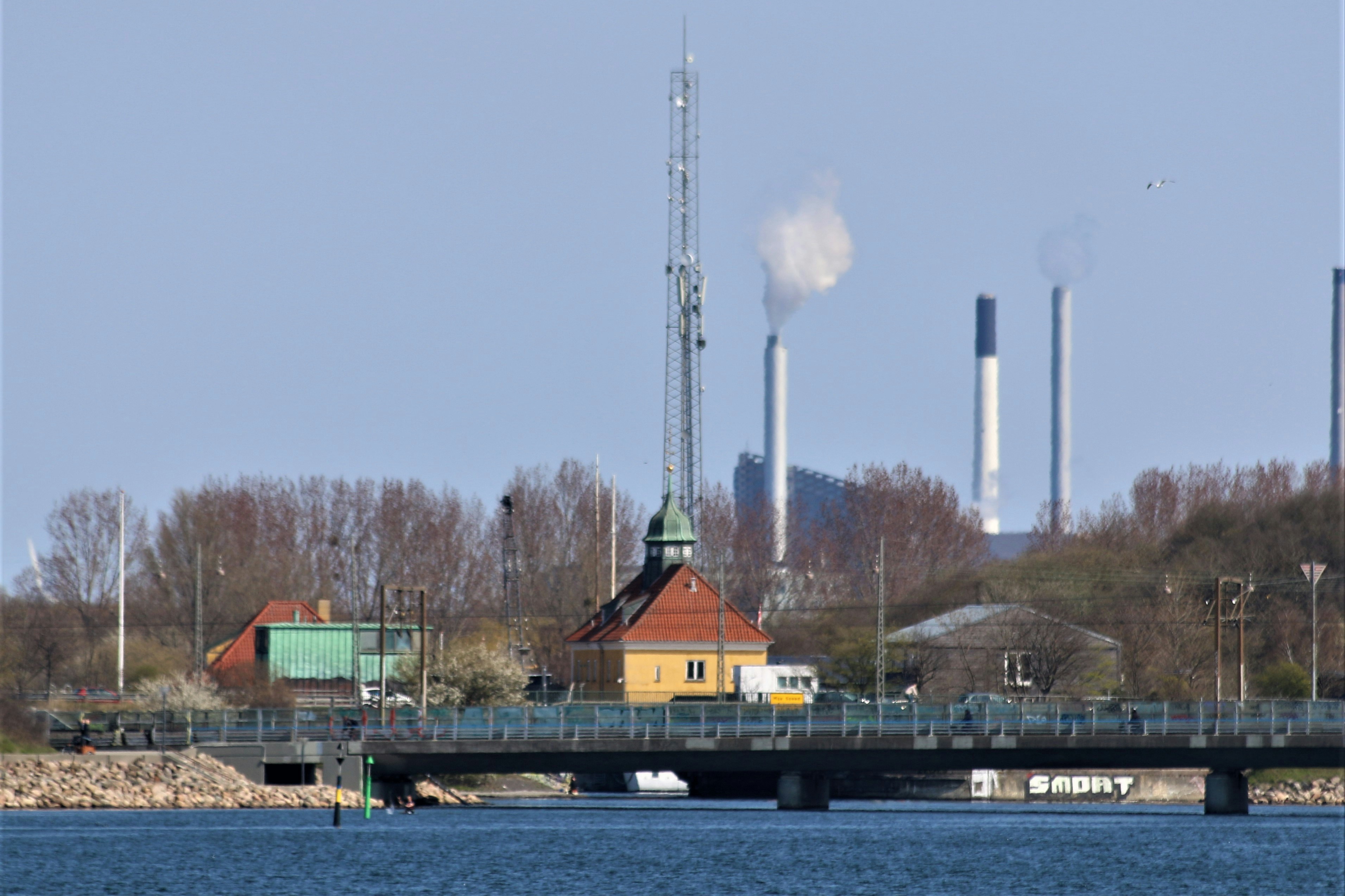 Tiny Harbor House Beneath Industrial Spires