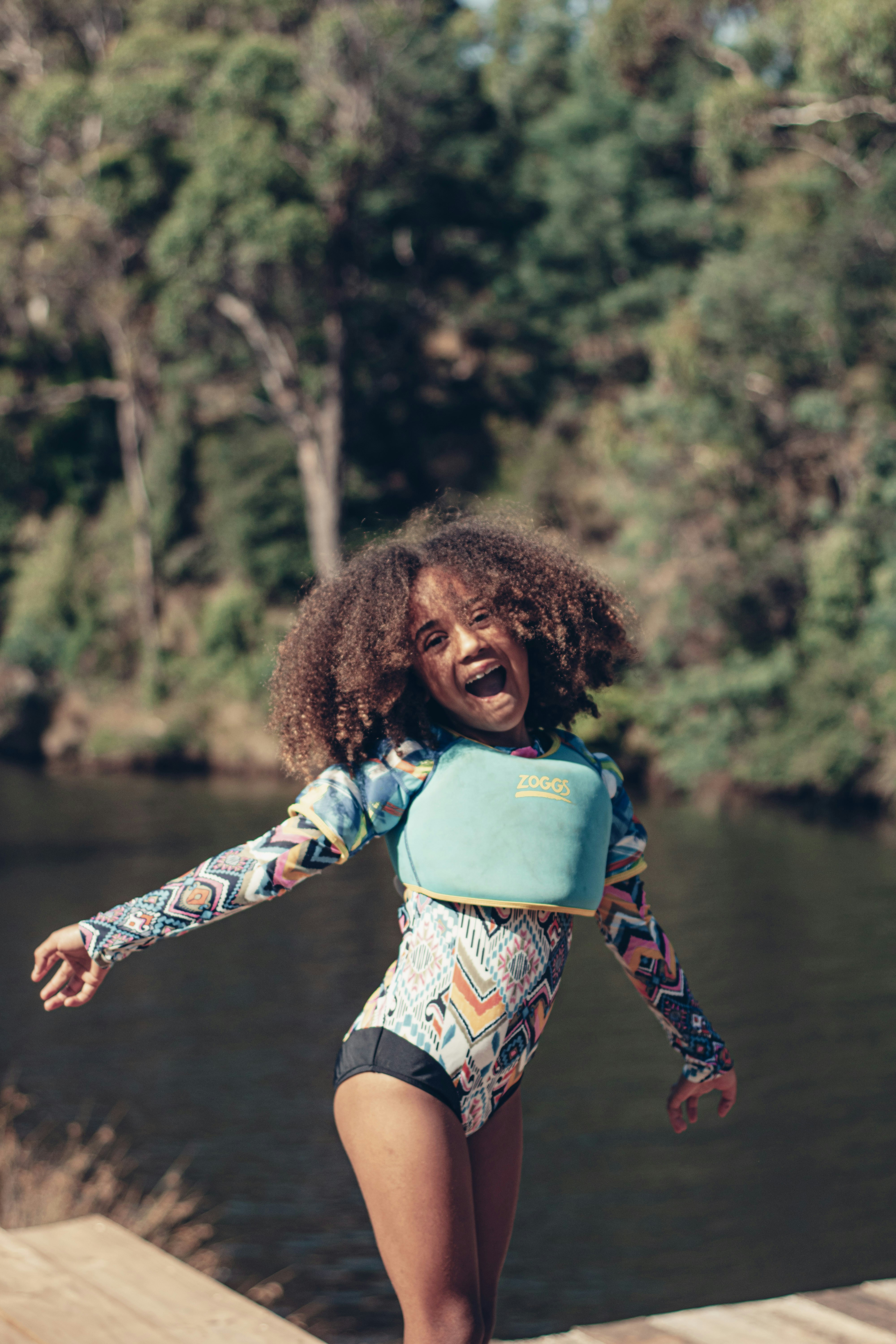 Dockside Joyride: A Girl Leaps Into Sunlit Waterline