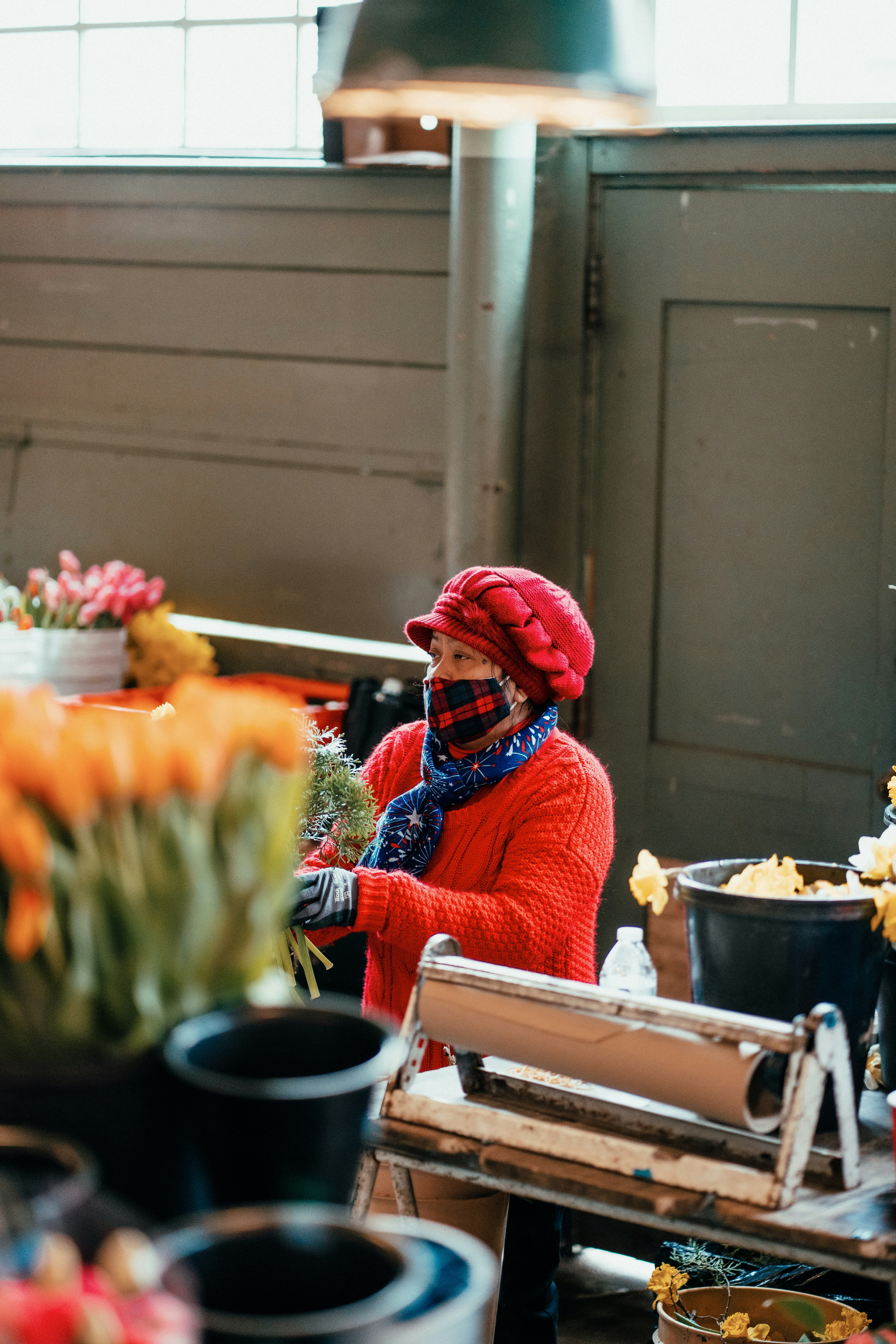 Red-Hatted Florist at a Tulip Stall: Quiet Focus in a Historic Market