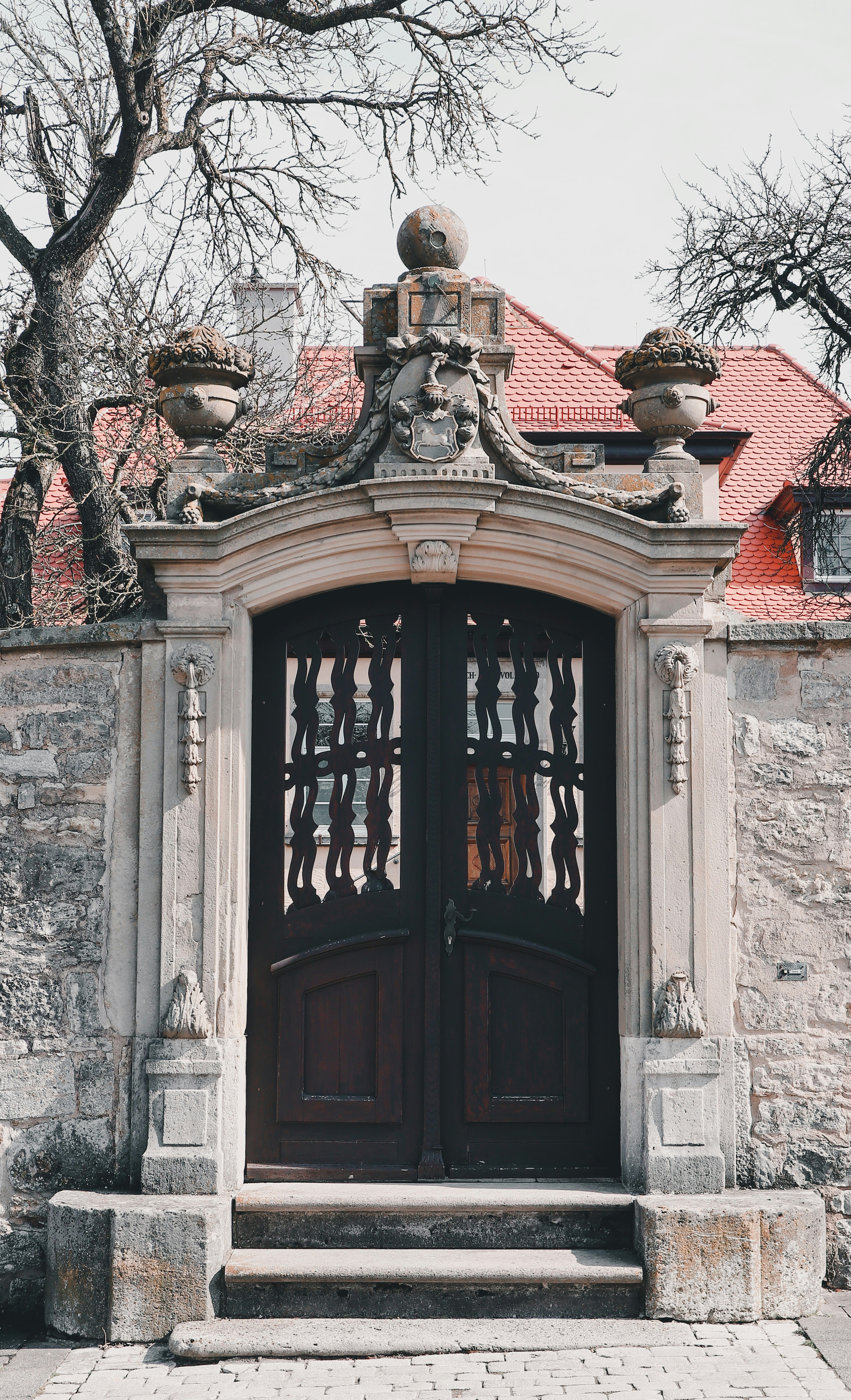 Portal of Time: Ornate Archway Framed by Winter Trees