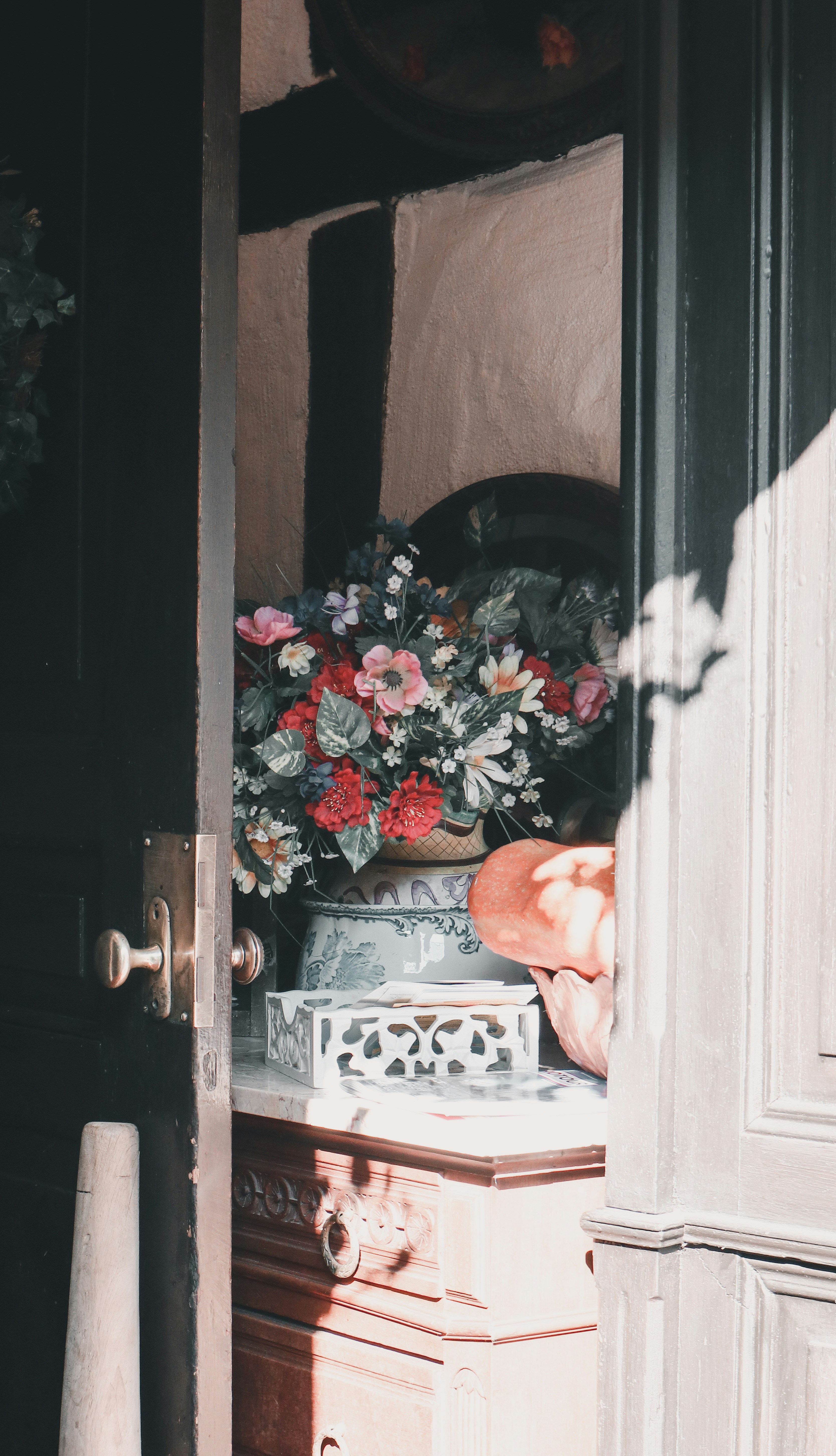 Sunlit Shrine of Flowers at a Doorway
