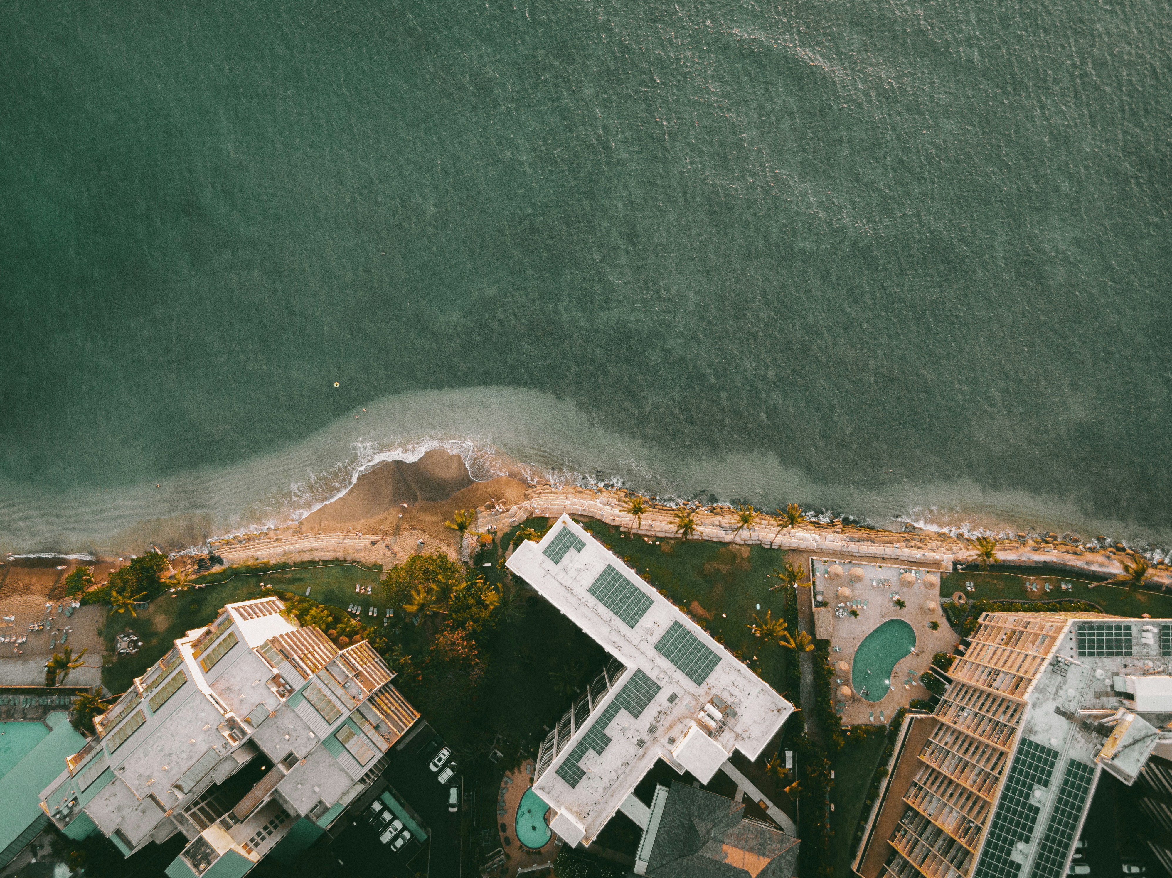 水域の隣の都市の航空写真の写真 – Unsplashの陸の無料画像