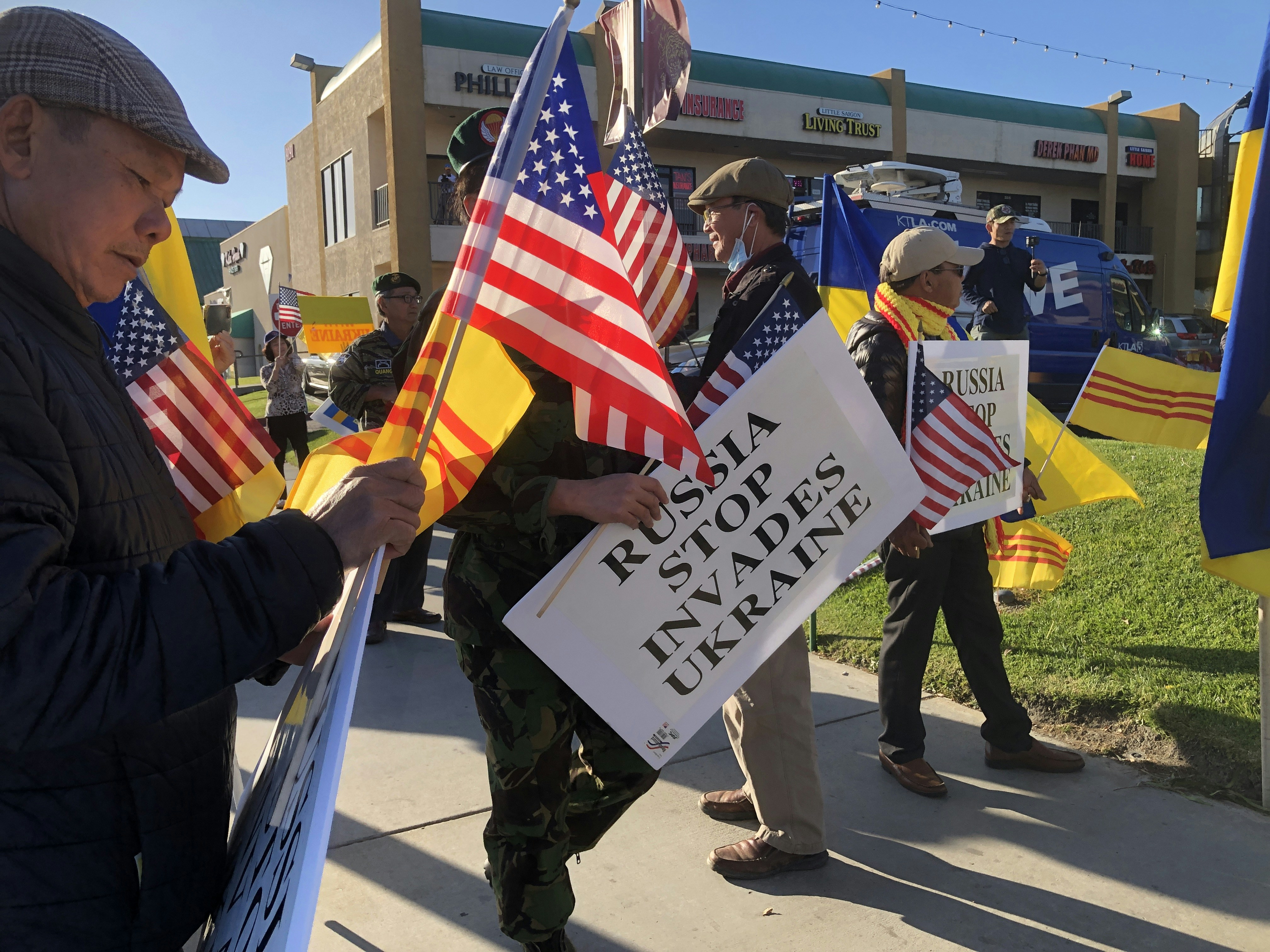 A group of people holding flags and signs photo – Free Little saigon ...