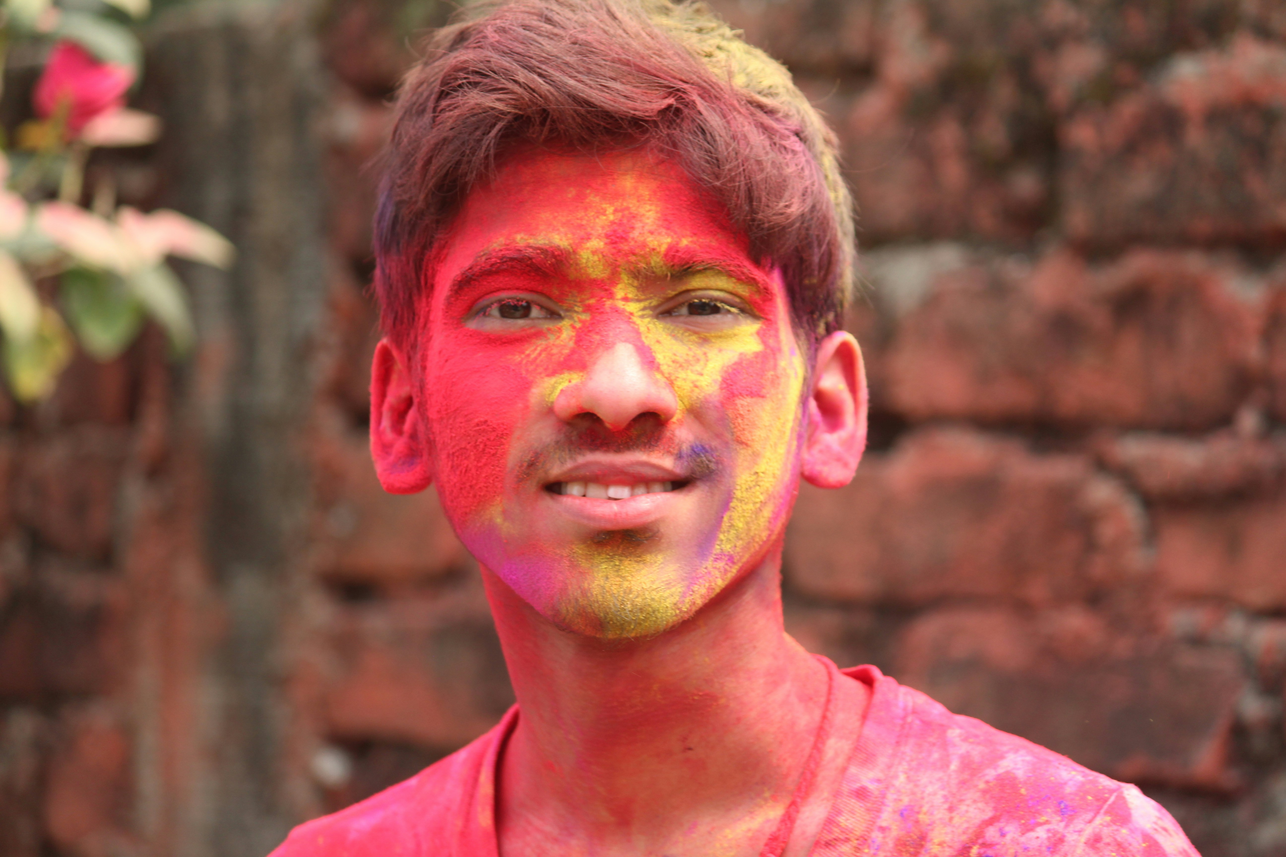 A young man is covered in yellow and pink paint photo – Free Boy Image ...