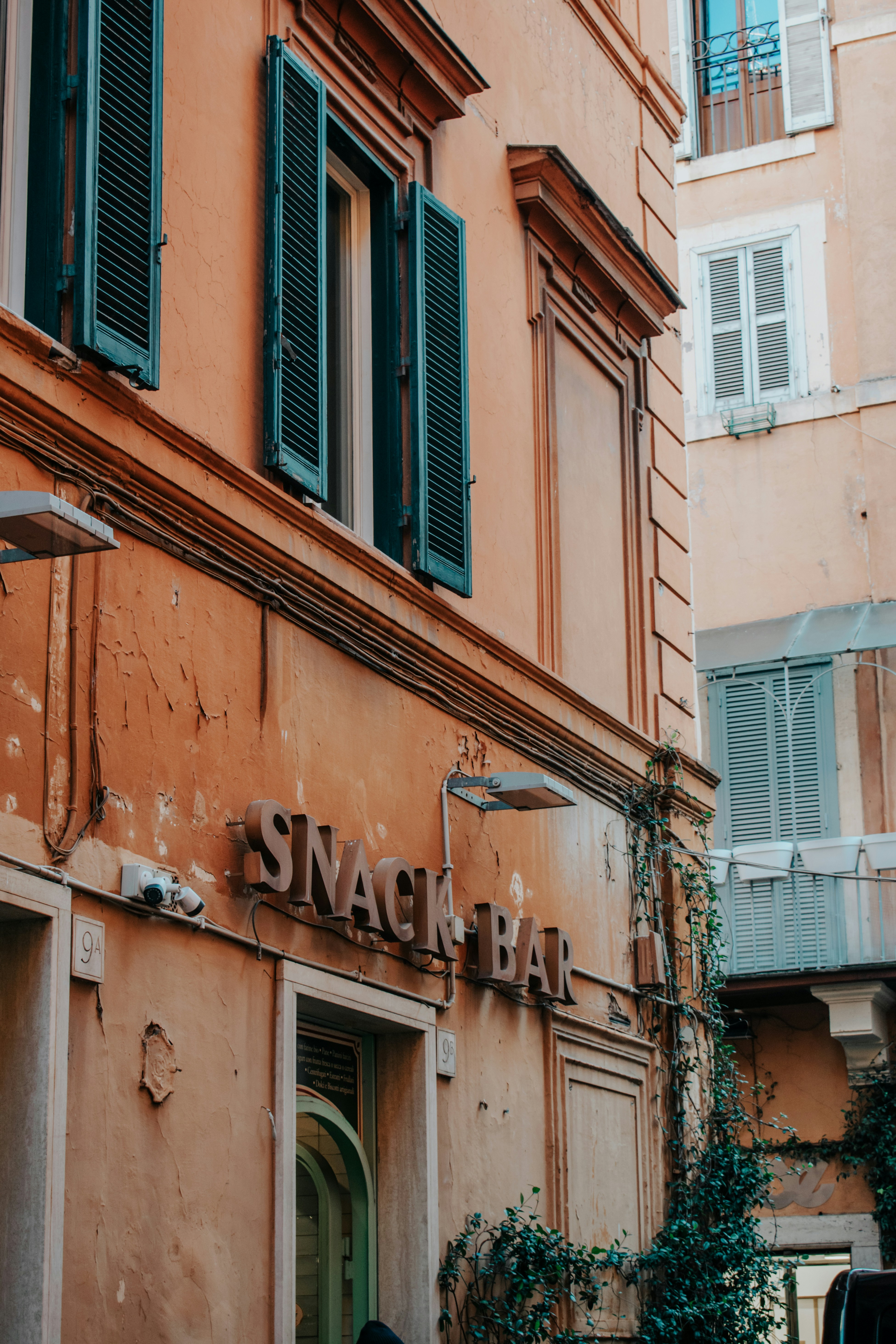 Sunlit Street Café: A Summer Facade with a Snack Bar