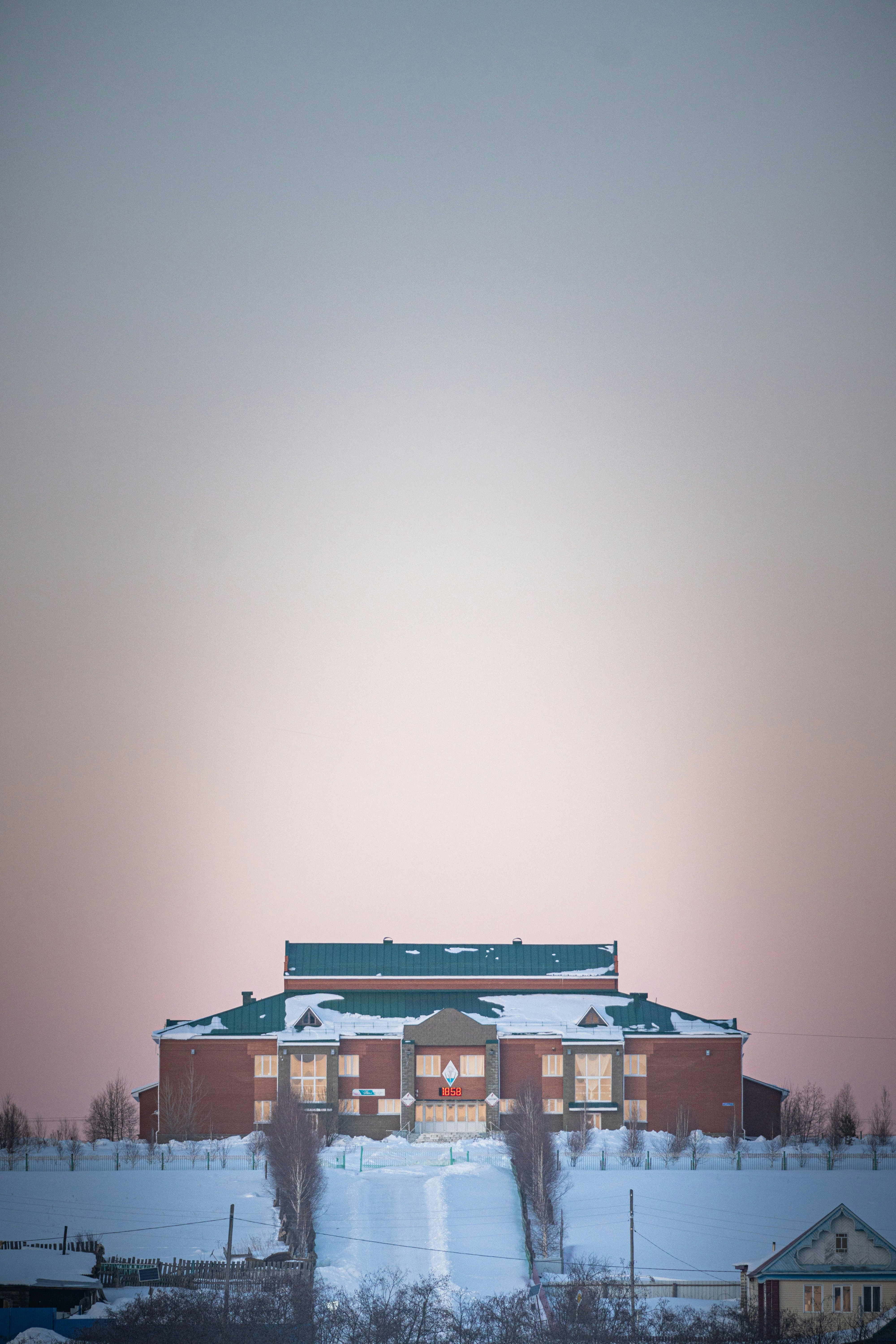 Pastel Dawn Embraces a Snowbound Brick Campus
