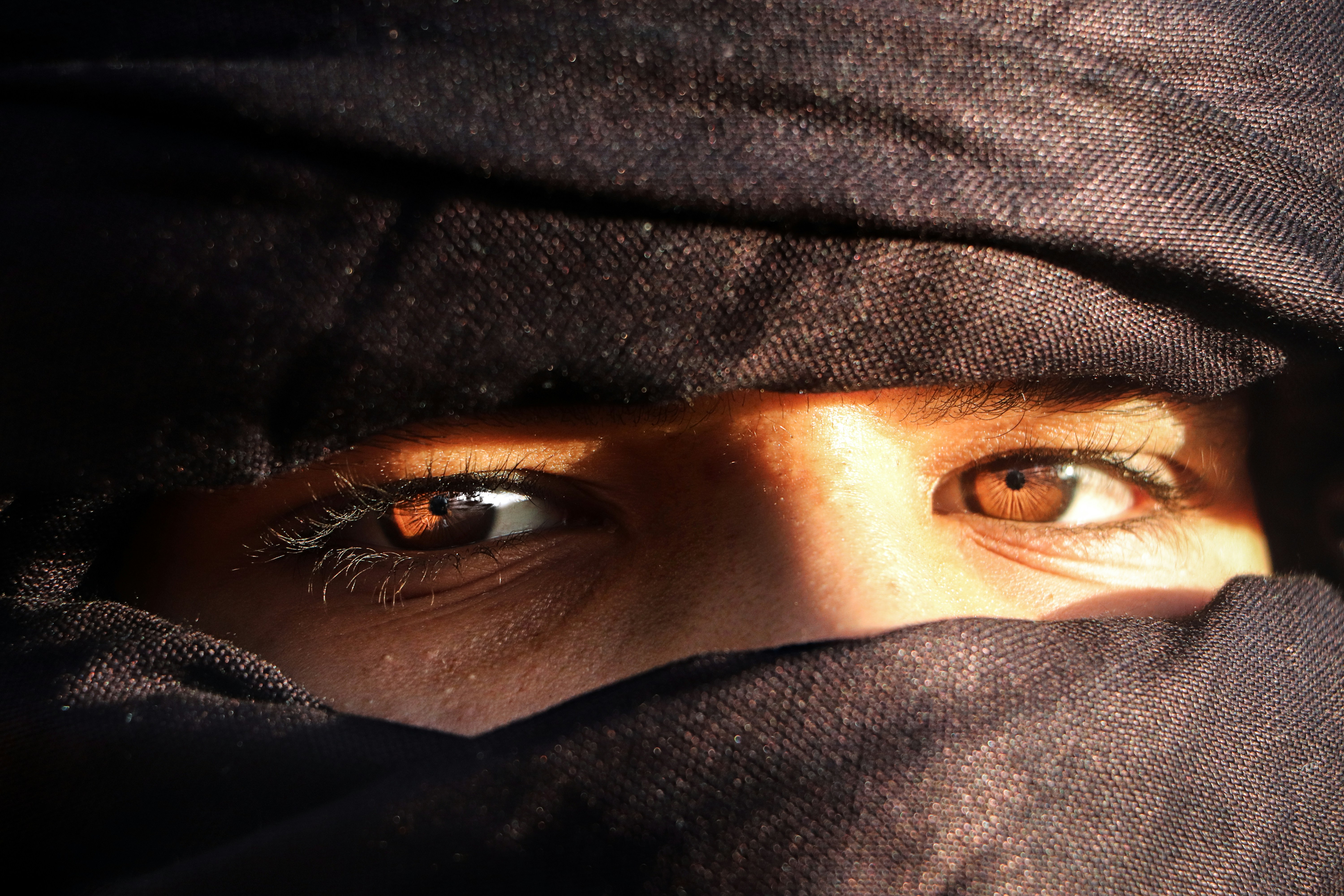 A close up of a person's eyes with a black cloth covering them photo ...