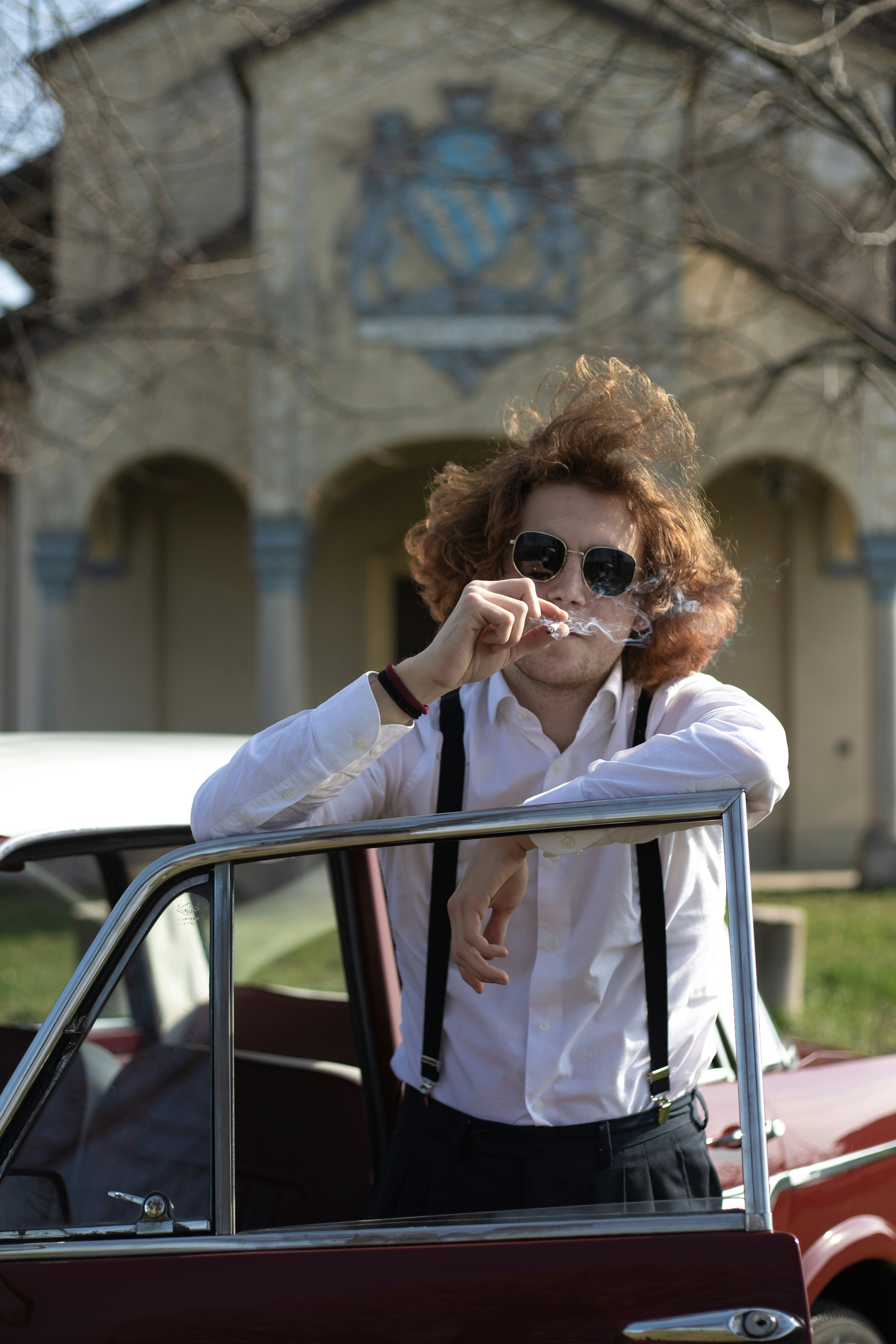 Dapper Pause: Smoke Break by a Vintage Convertible