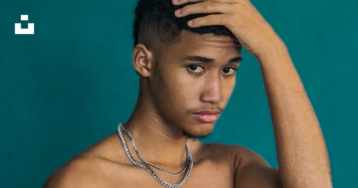 A Shirtless Man With A Chain Around His Neck Photo Free Dominican