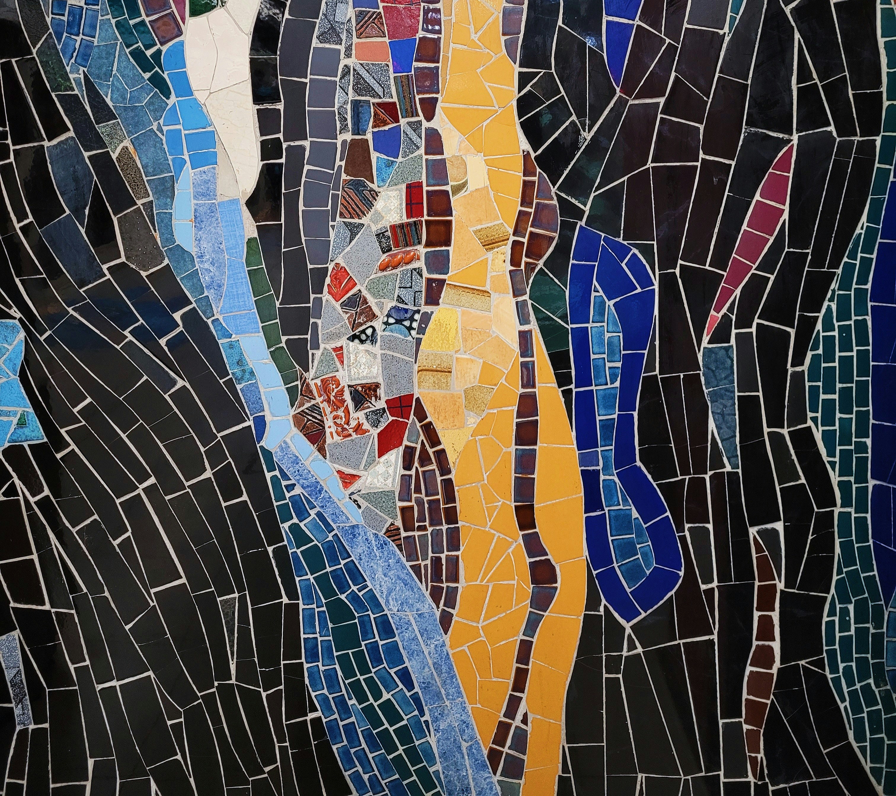 Colorful ribbons flow through a dark tiled mosaic, creating an abstract, motion-filled scene.