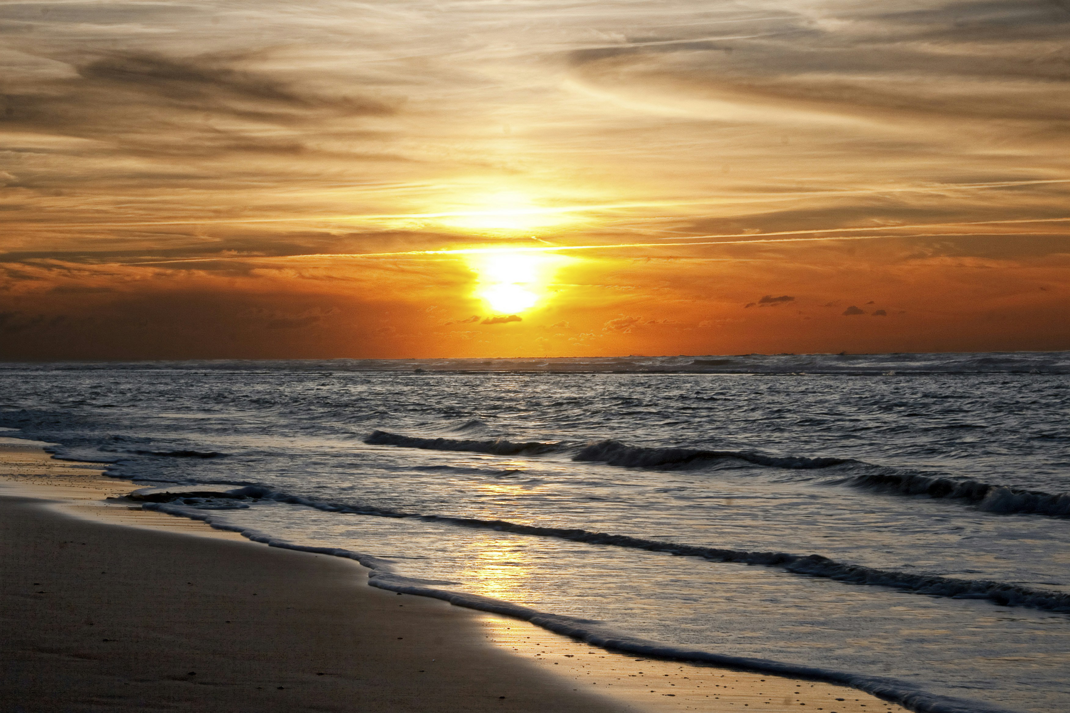 The sun is setting over the ocean on the beach photo – Free Sea Image ...