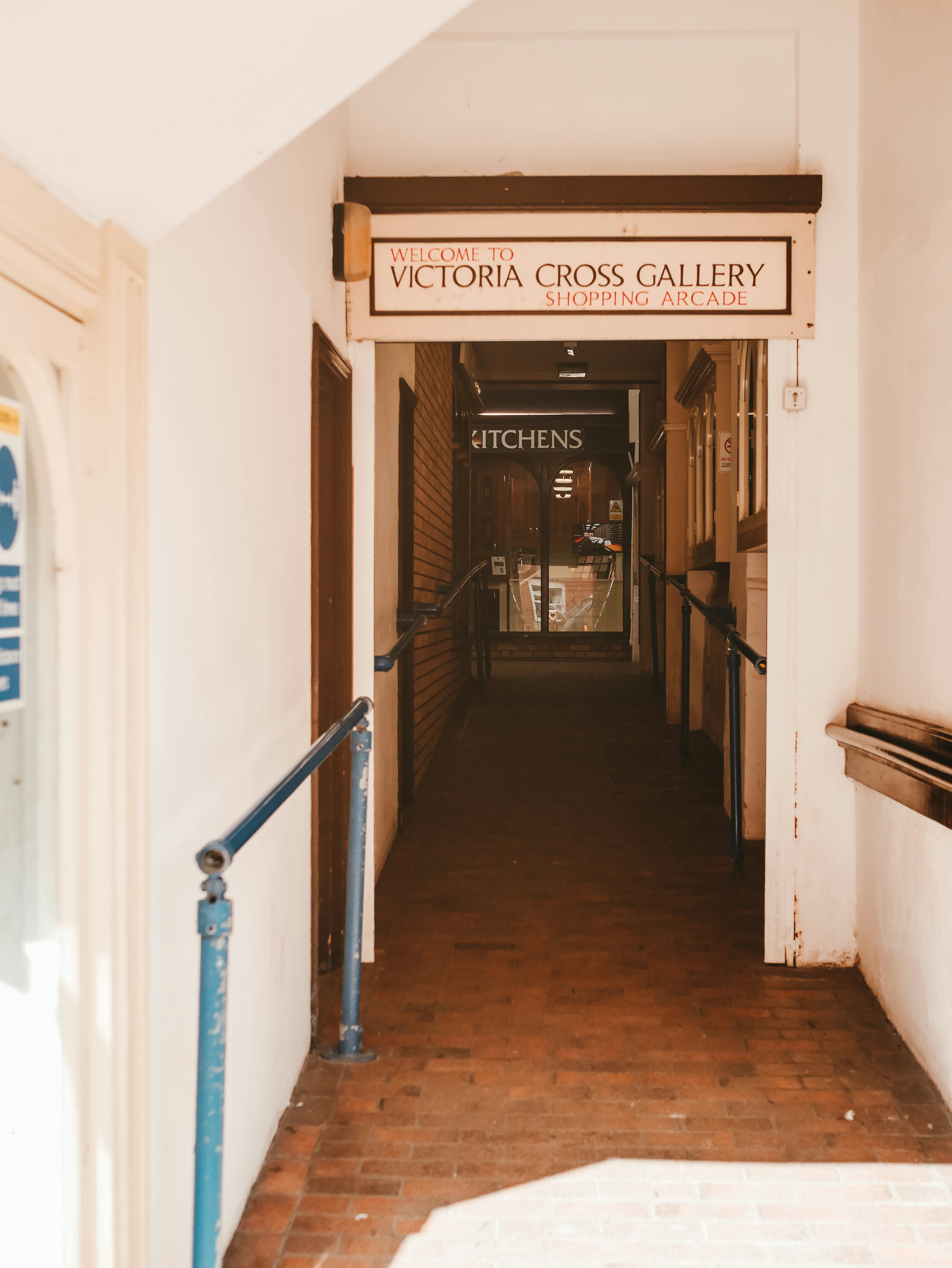 a long hallway with a sign that says victoria cross gallery