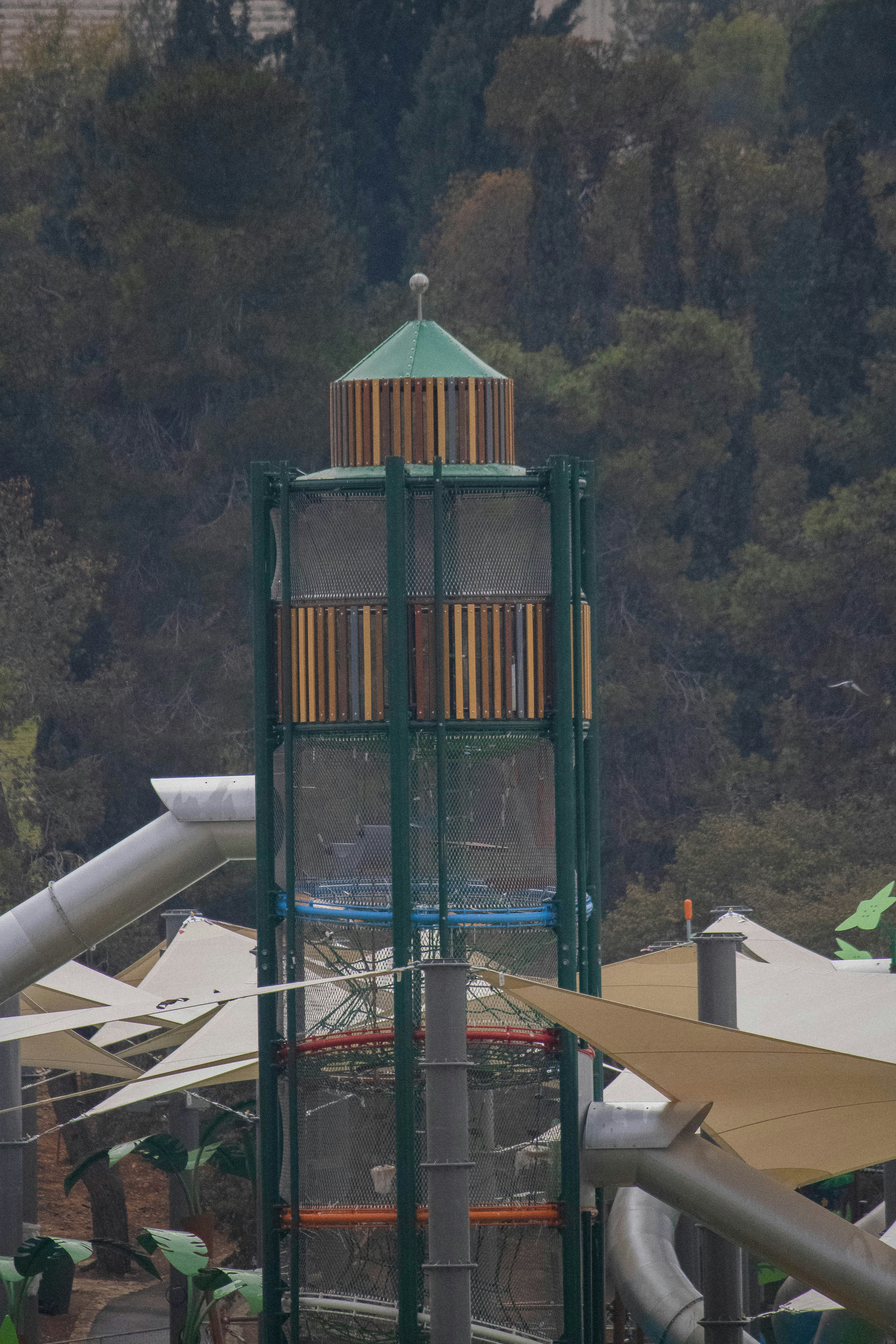 A tall tower with a water slide in the background photo – Free Grey ...