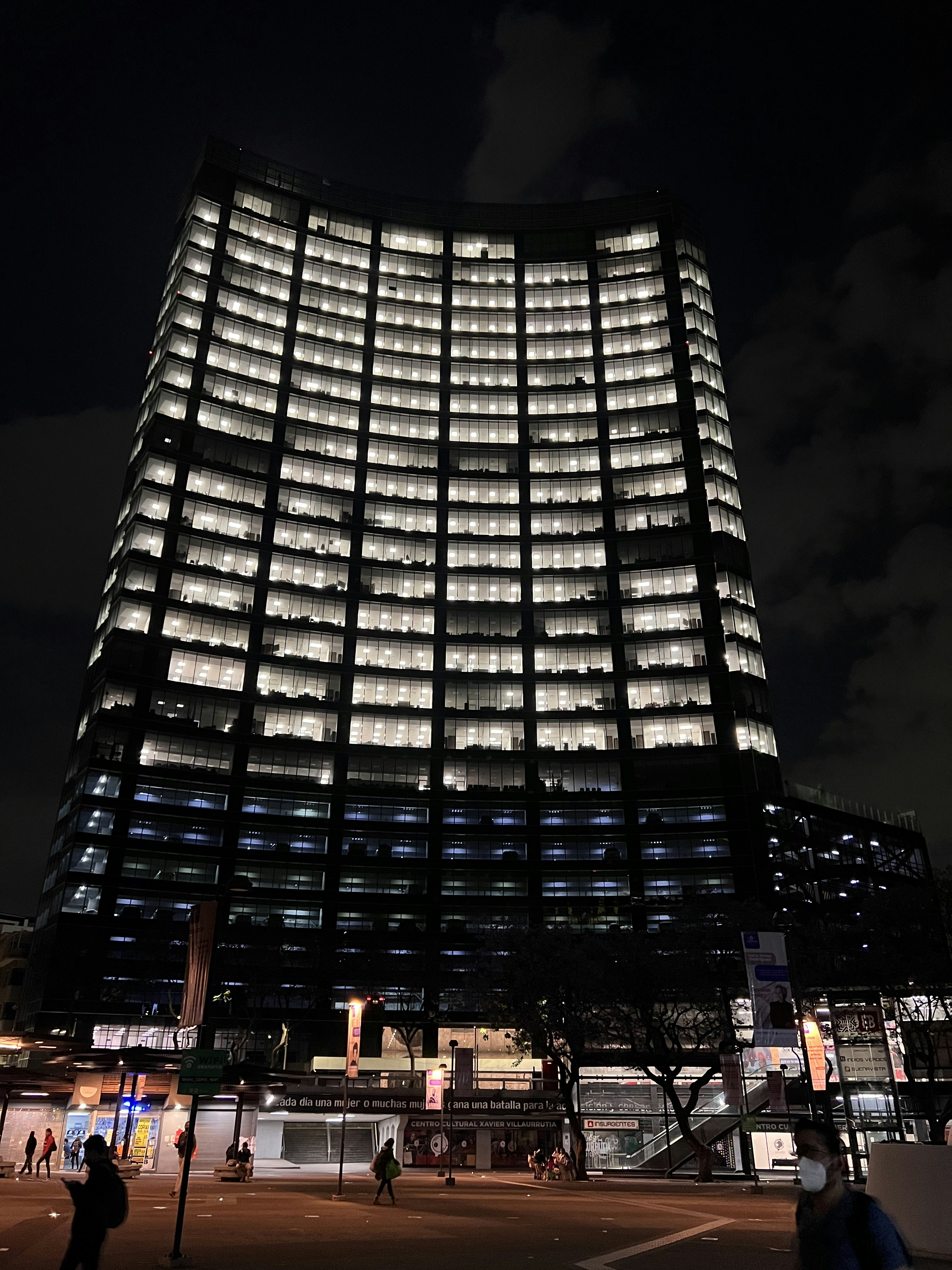 A very tall building lit up at night photo – Free City Image on Unsplash