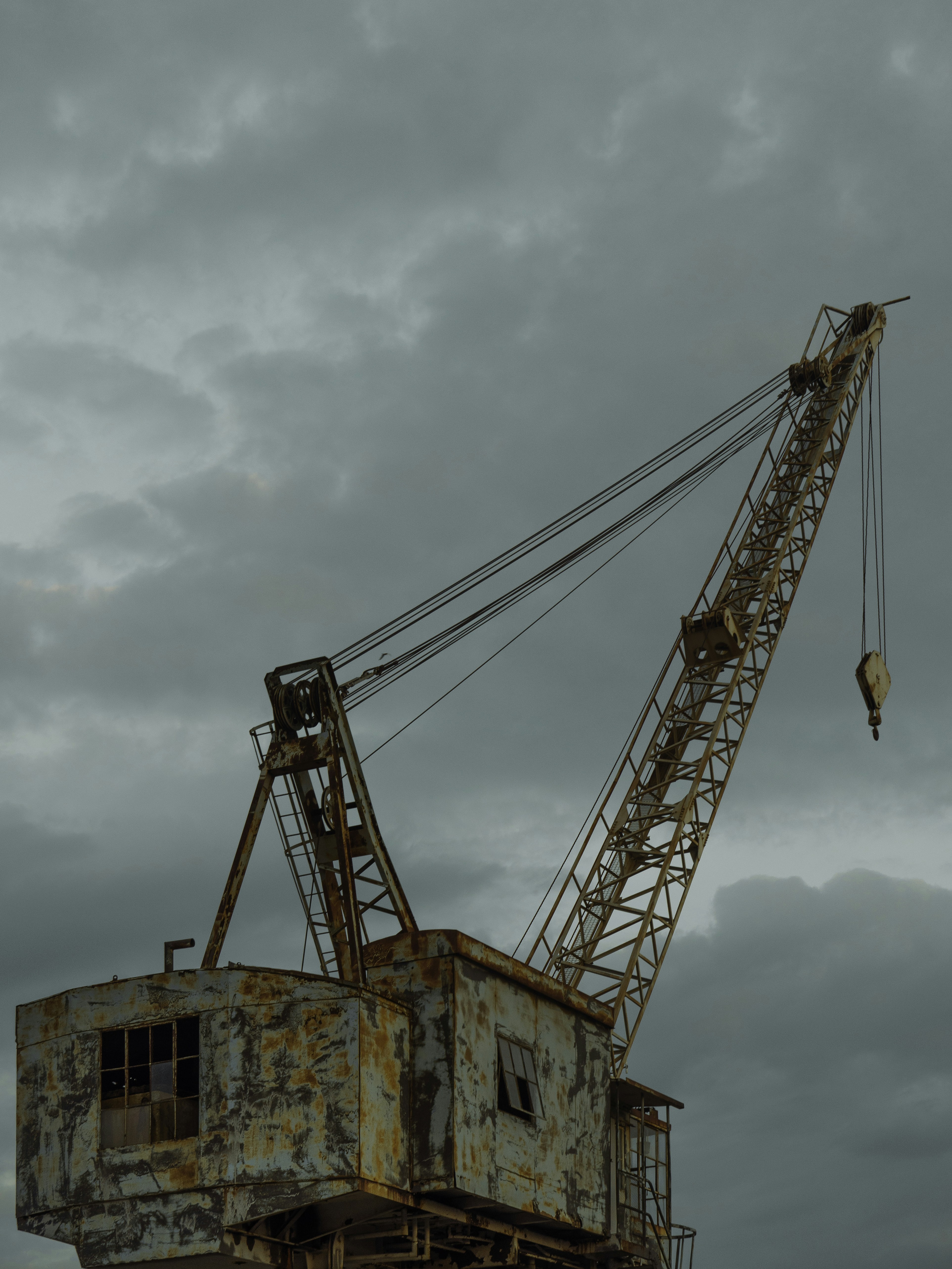 Rust-Weathered Crane Reaches Into a Moody Sky