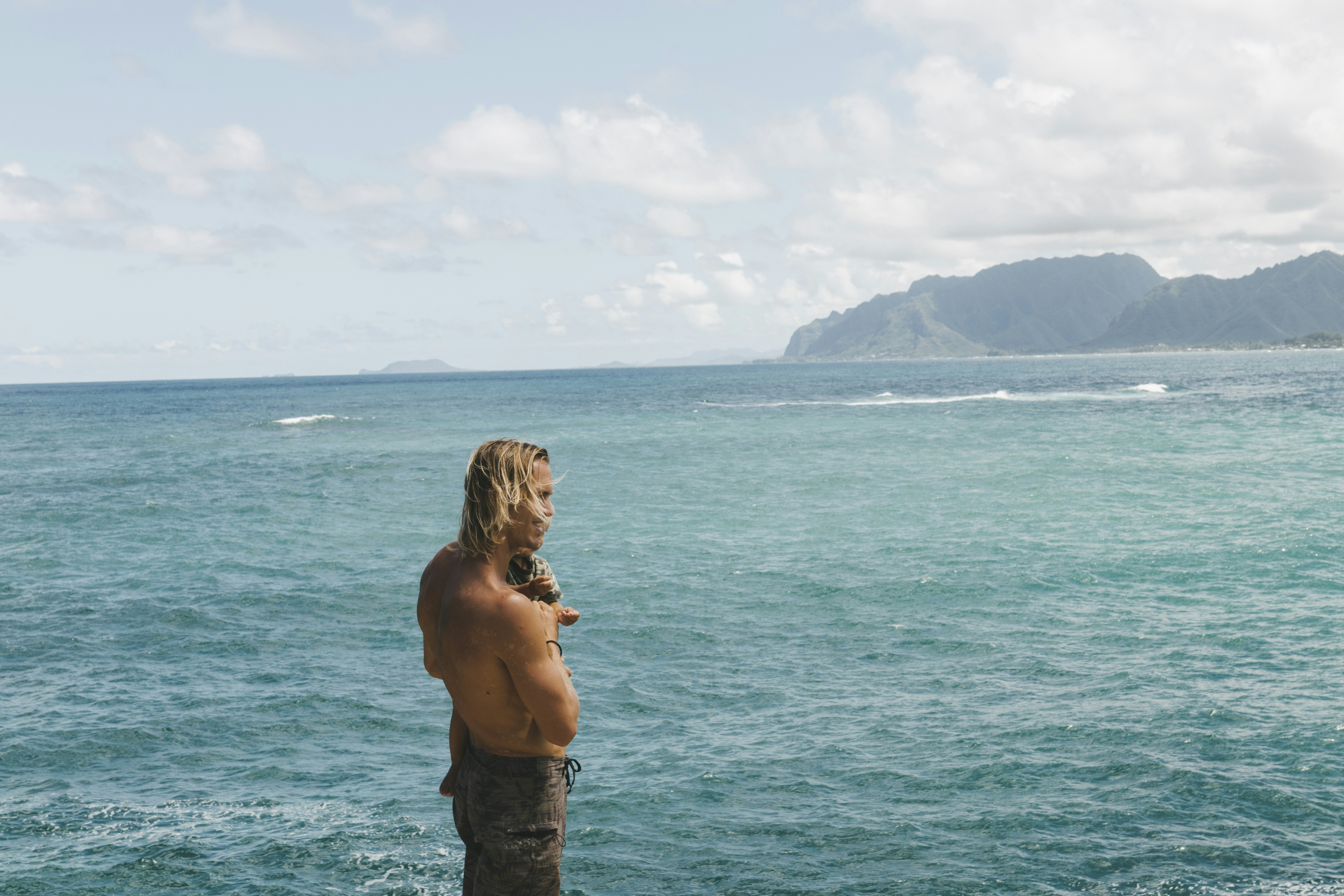 Lone Figure on Turquoise Tide: Contemplation at the Sea's Edge