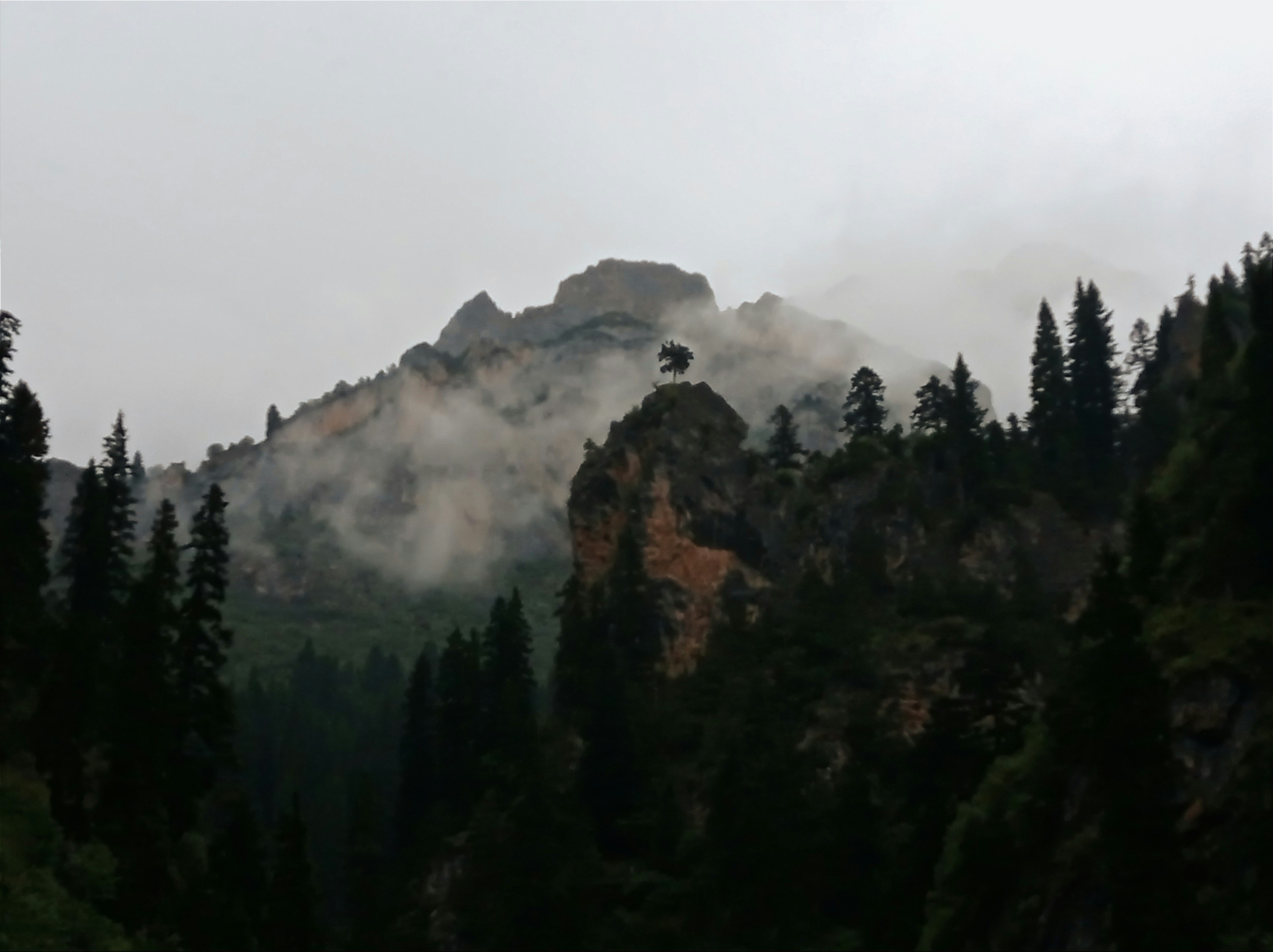 the famous Yellow Mountain range of Shanghai China - this is a typical picture of the gloomy landscape created by the fog and sheer mountain ranges