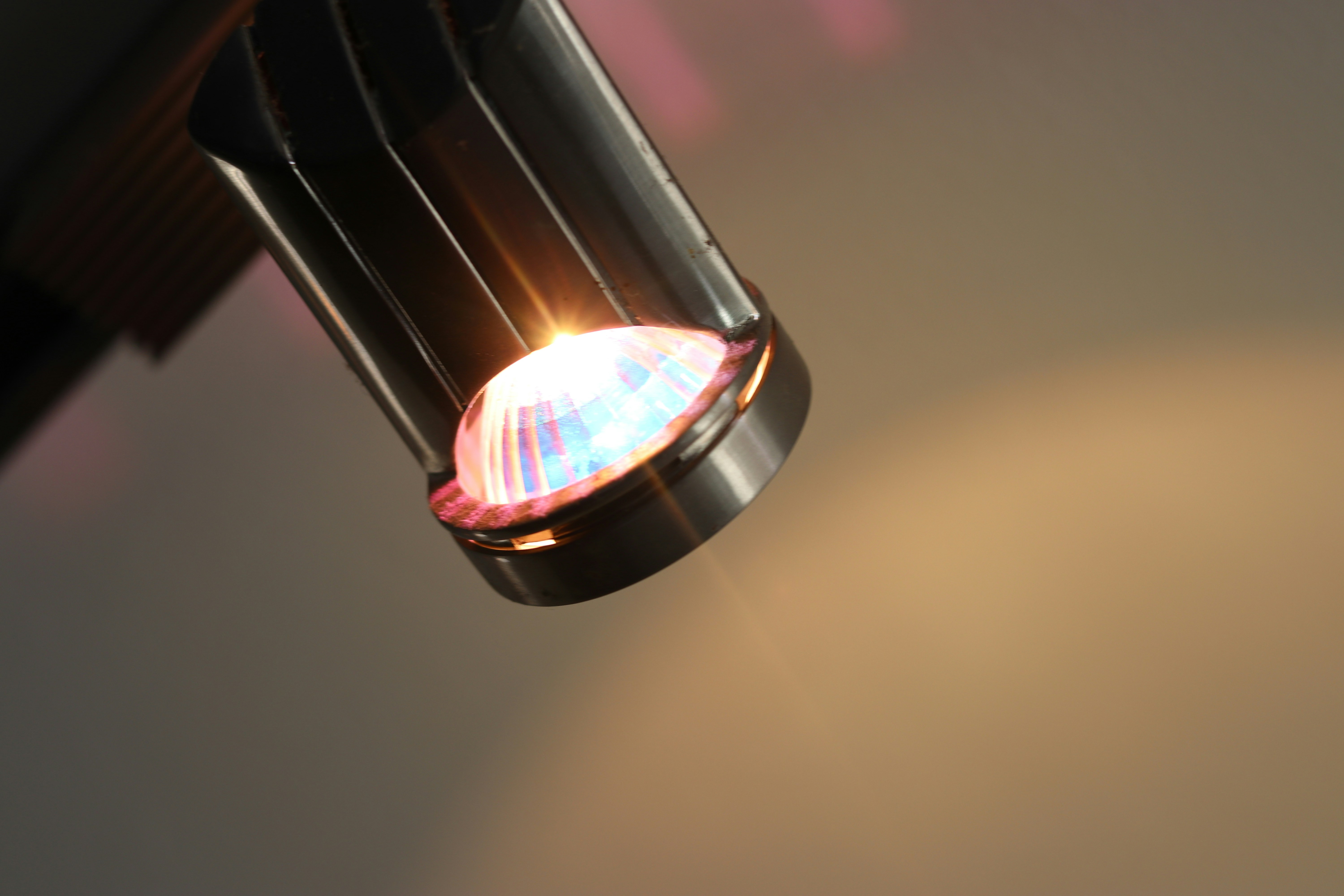 Edge of Gleam: Close-Up on a Precision Lens in Warm Glow