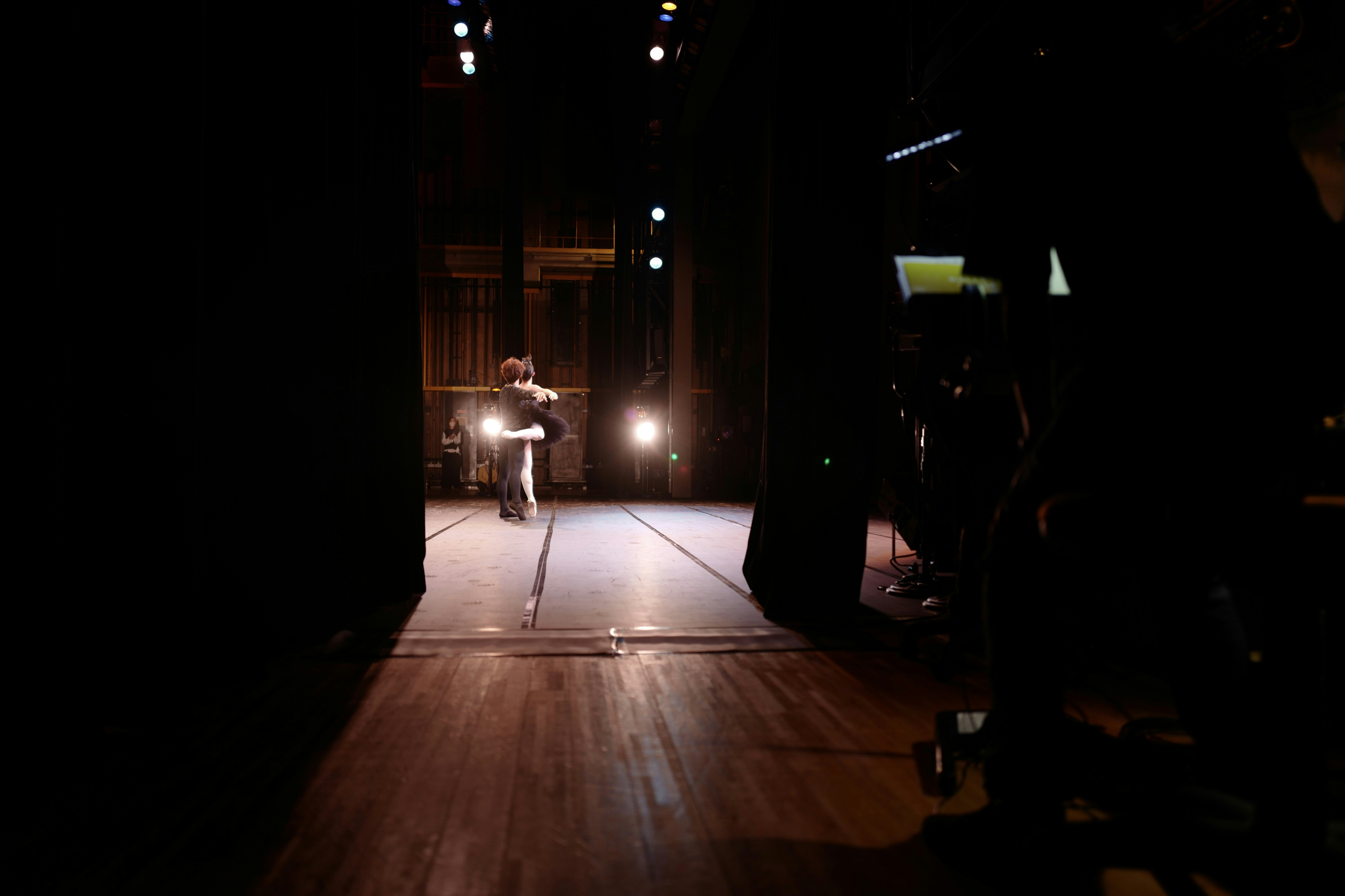 A person standing on a stage holding a microphone photo – Free Dancer ...