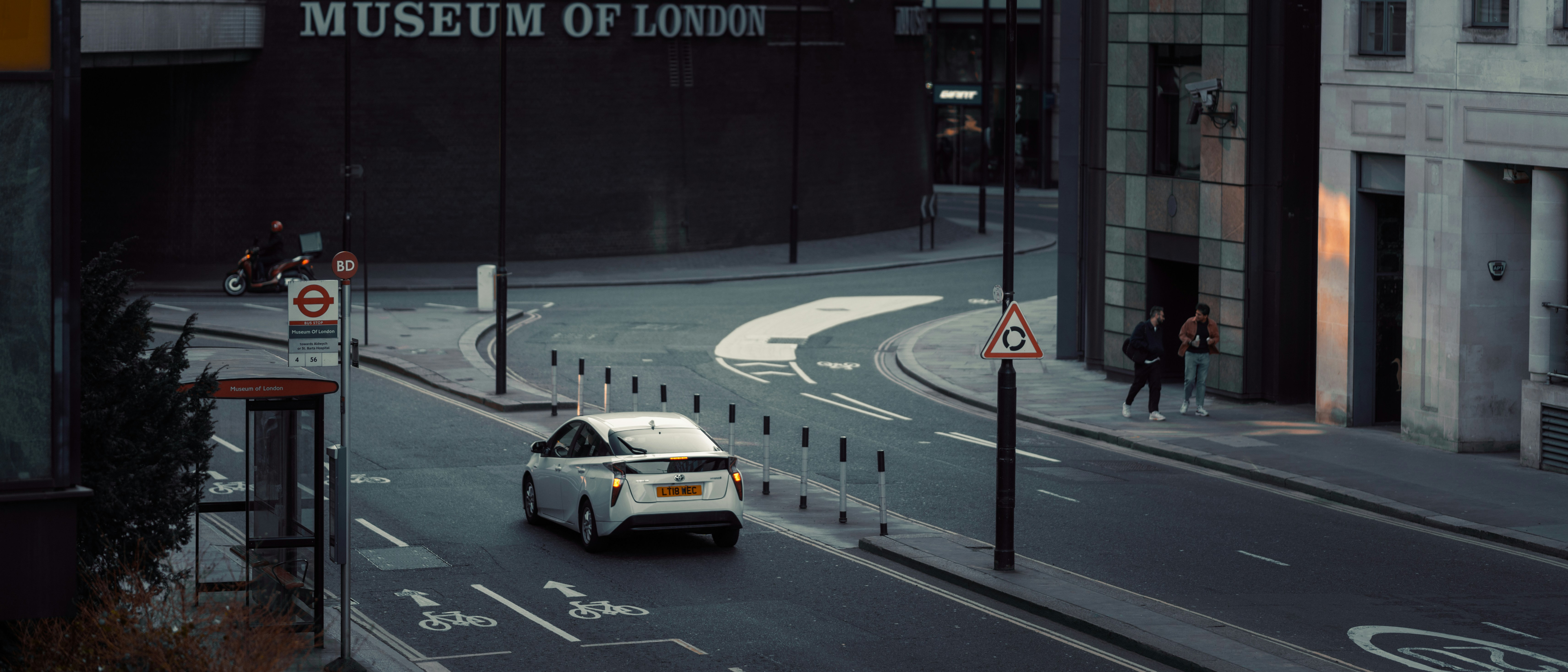 White Sedan Tracing a Quiet Curve by the Museum of London